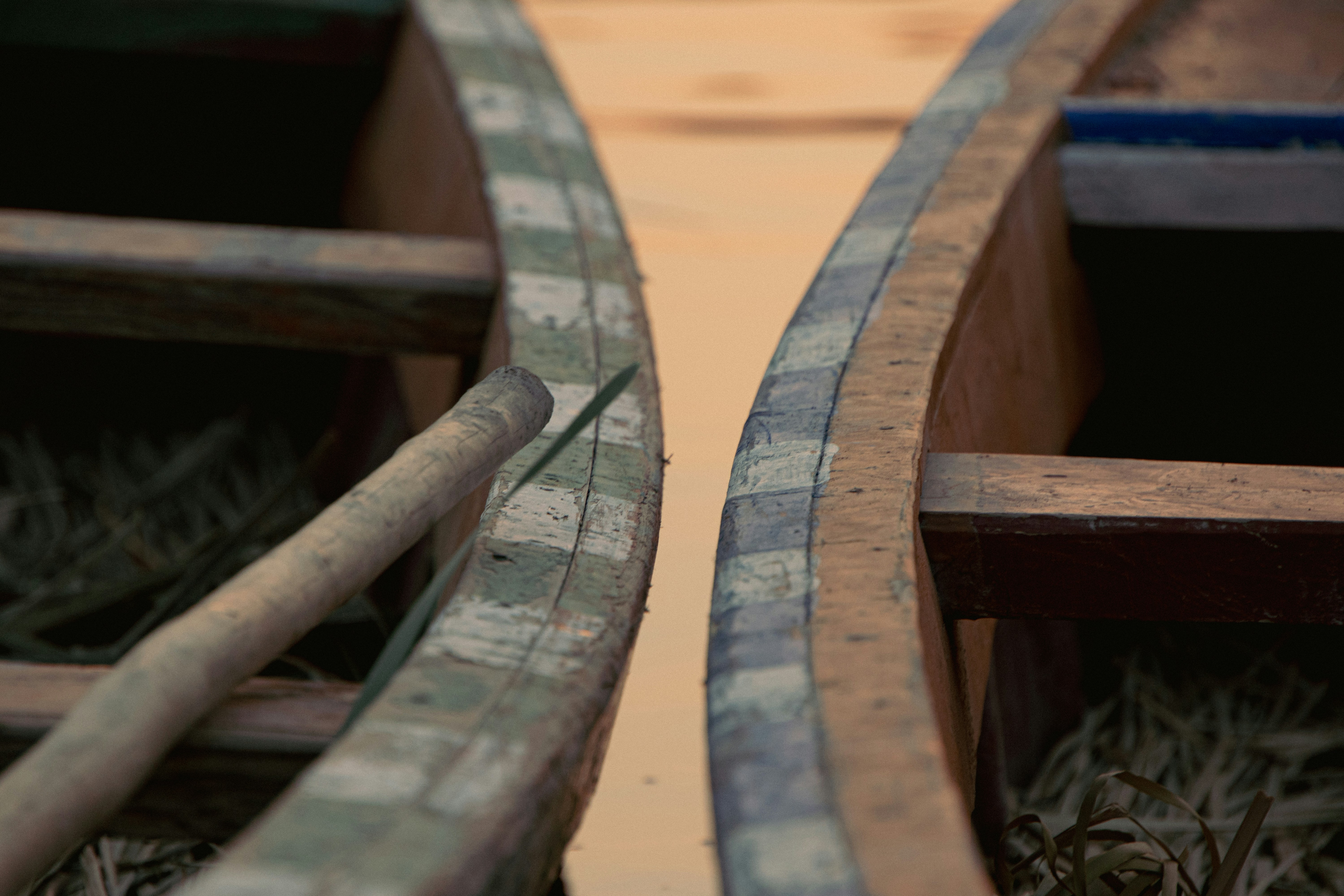 Between Painted Rails: A Narrow Canal Framed by Weathered Hulls