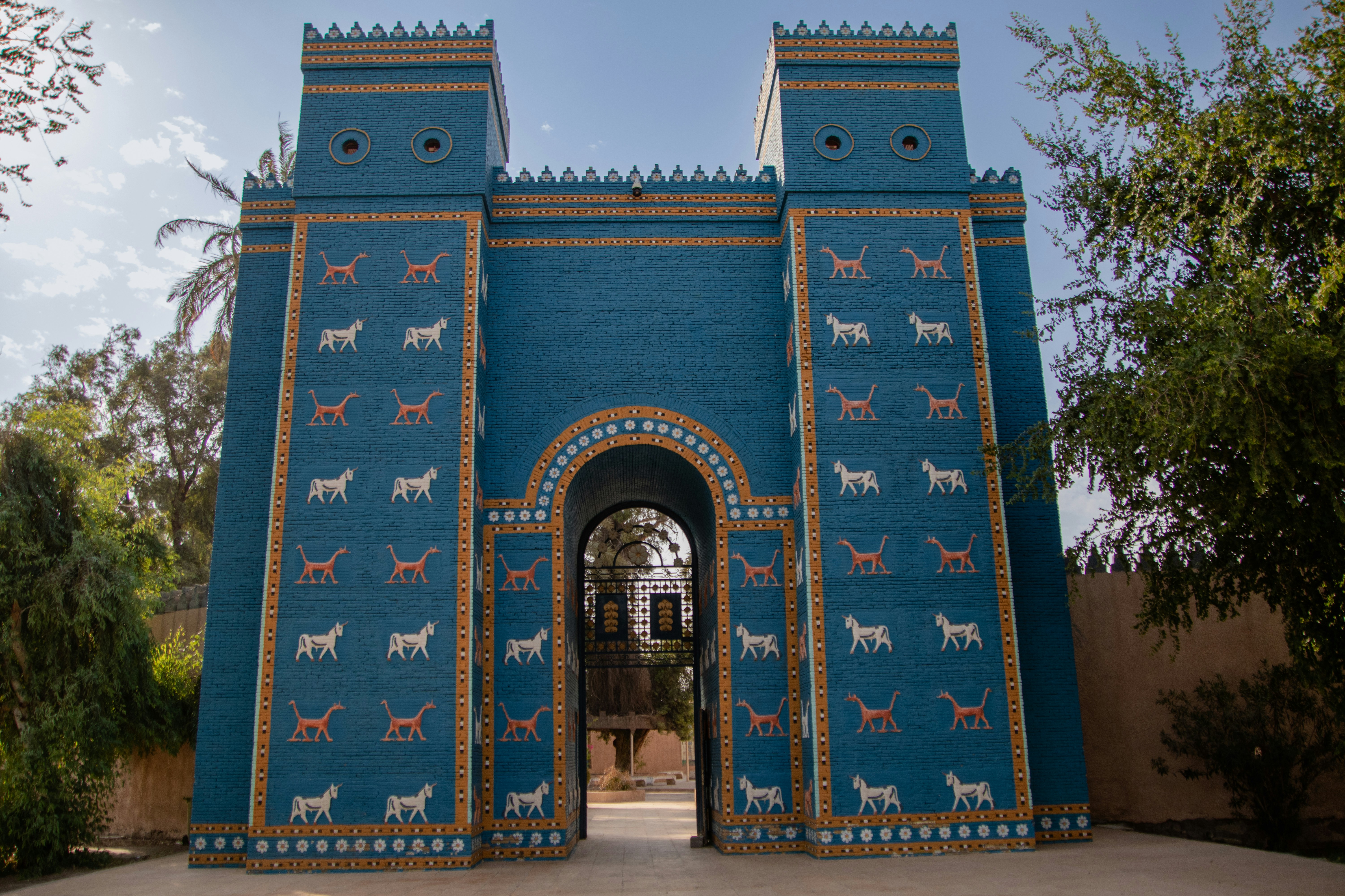 A large blue gate with horses painted on it