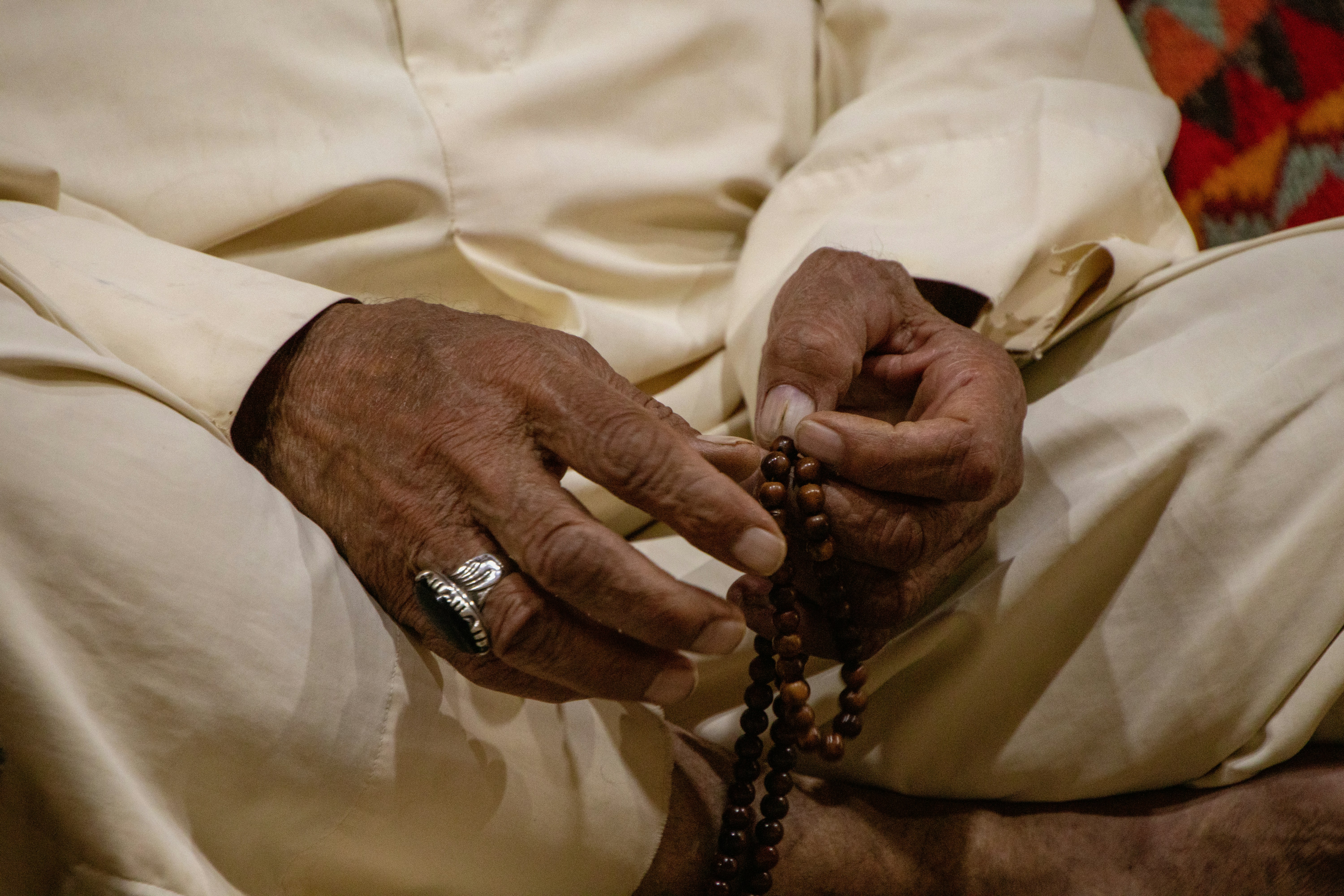 Prayer Beads in Gentle Light: Hands at Rest