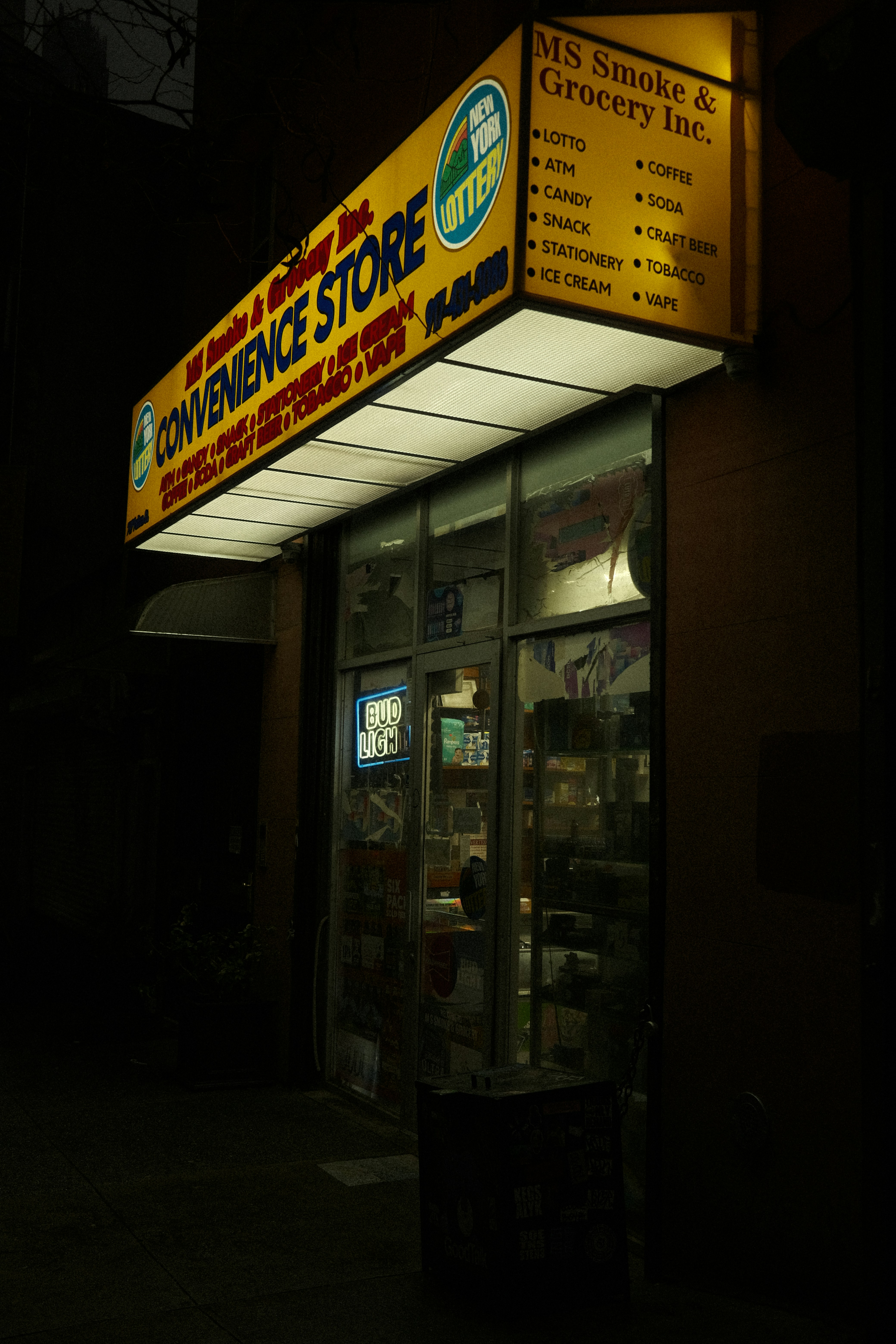 A convenience store lit up at night in the dark photo – Free Building ...