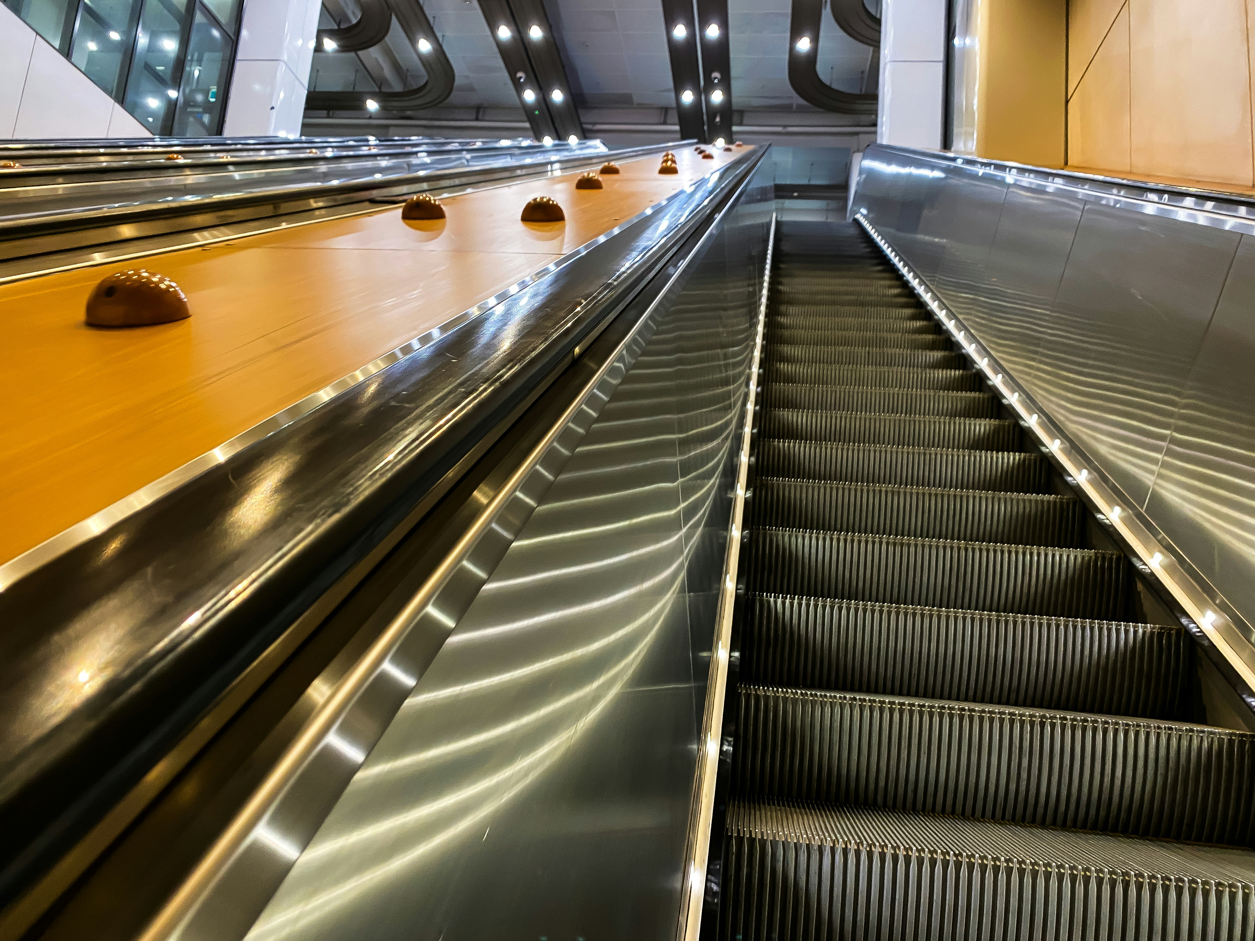 An escalator in a large building with metal railings photo – Free ...