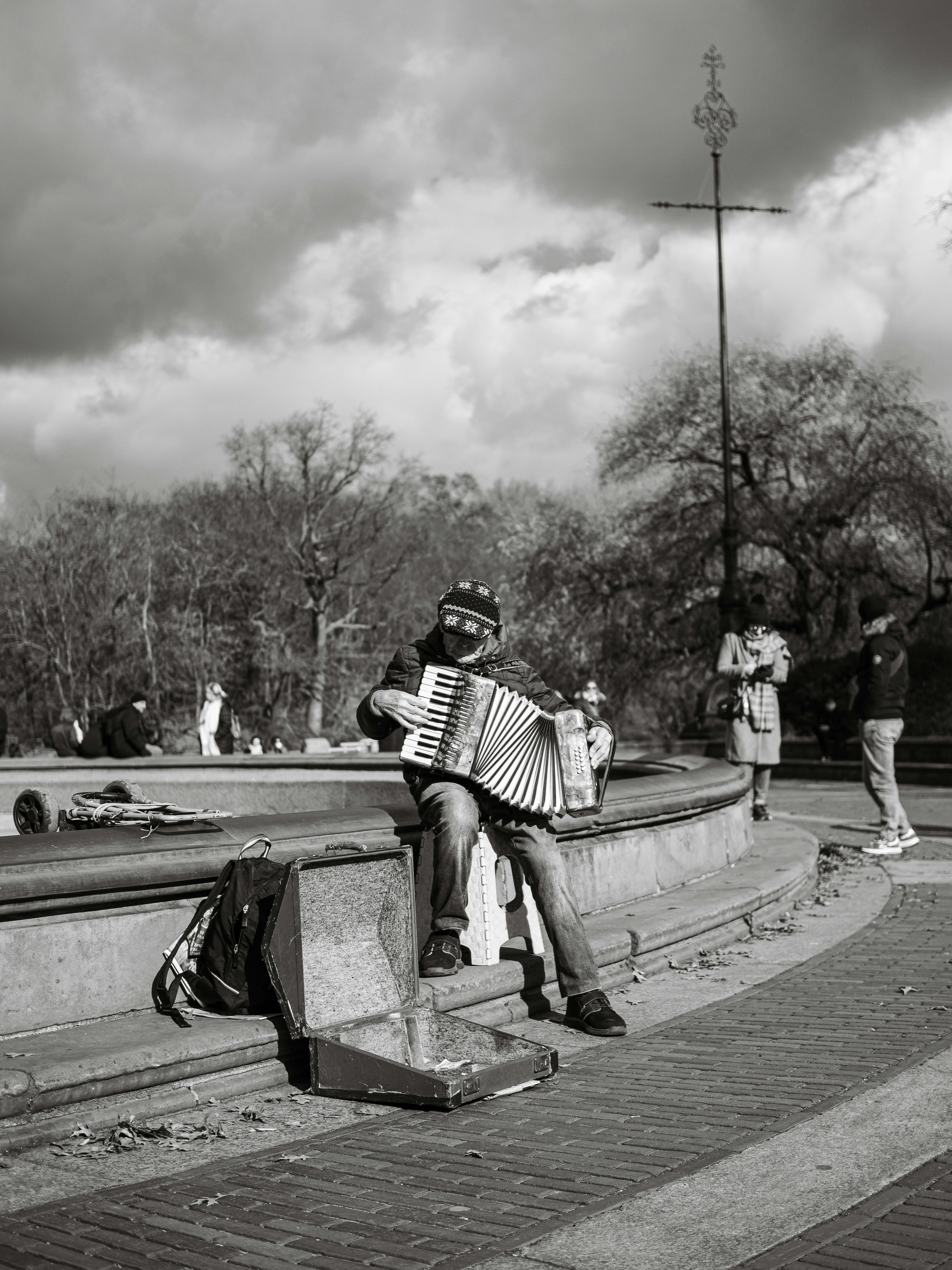 Accordion in the Circle: A Quiet Busker by the Fountain