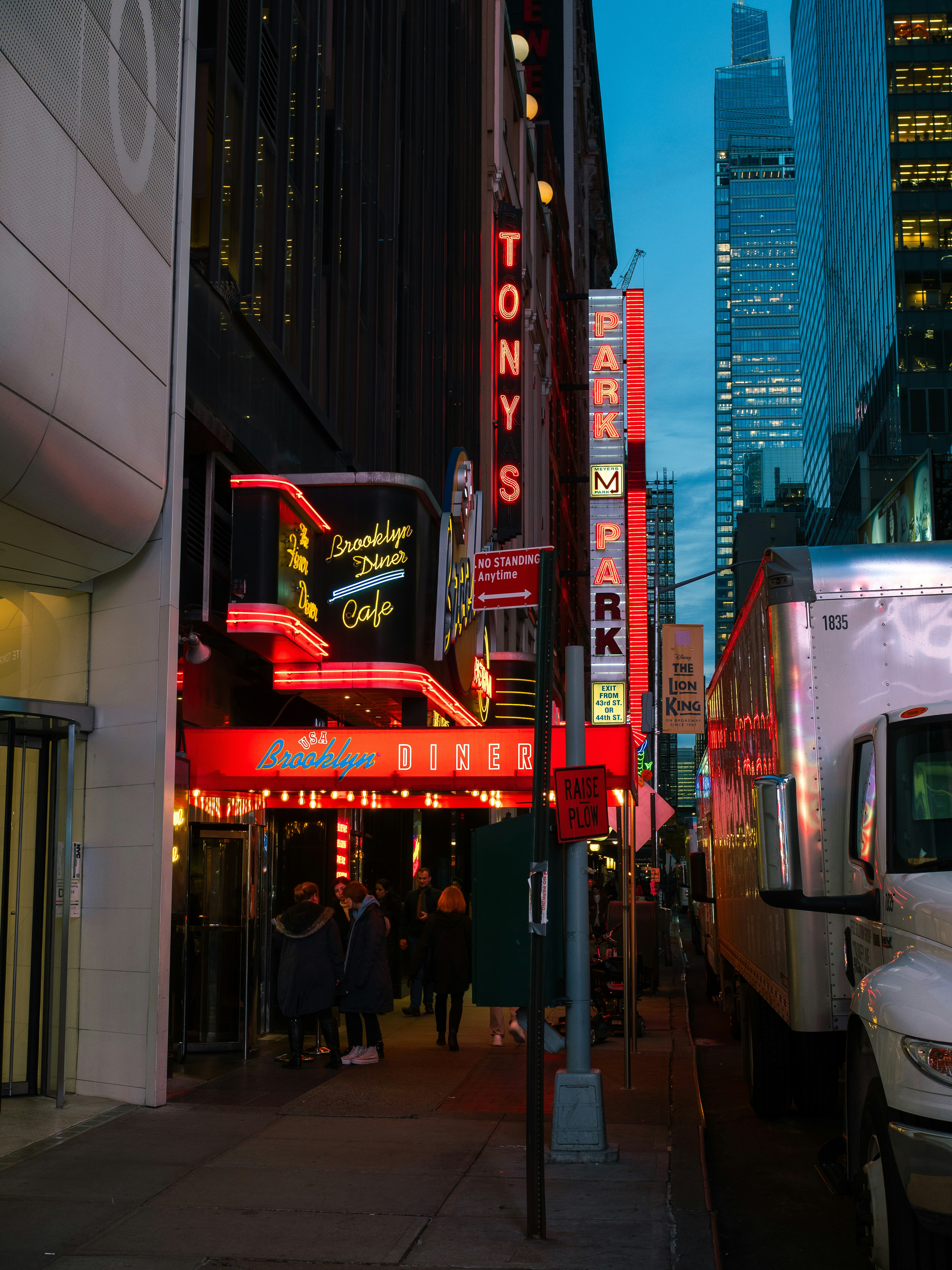 A busy city street at night with neon signs
