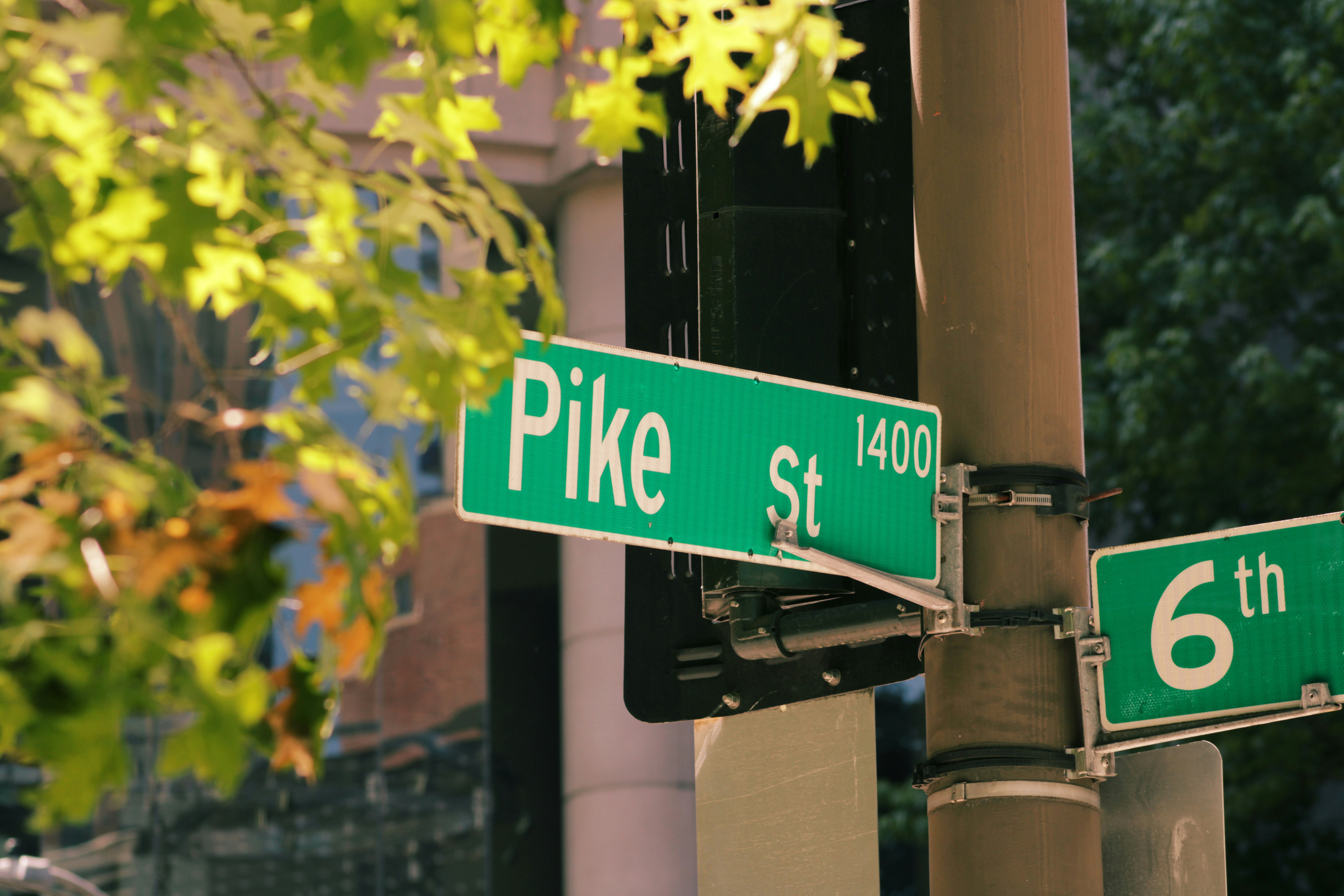 A street sign on the corner of pike st and 6th st photo – Free Seattle ...