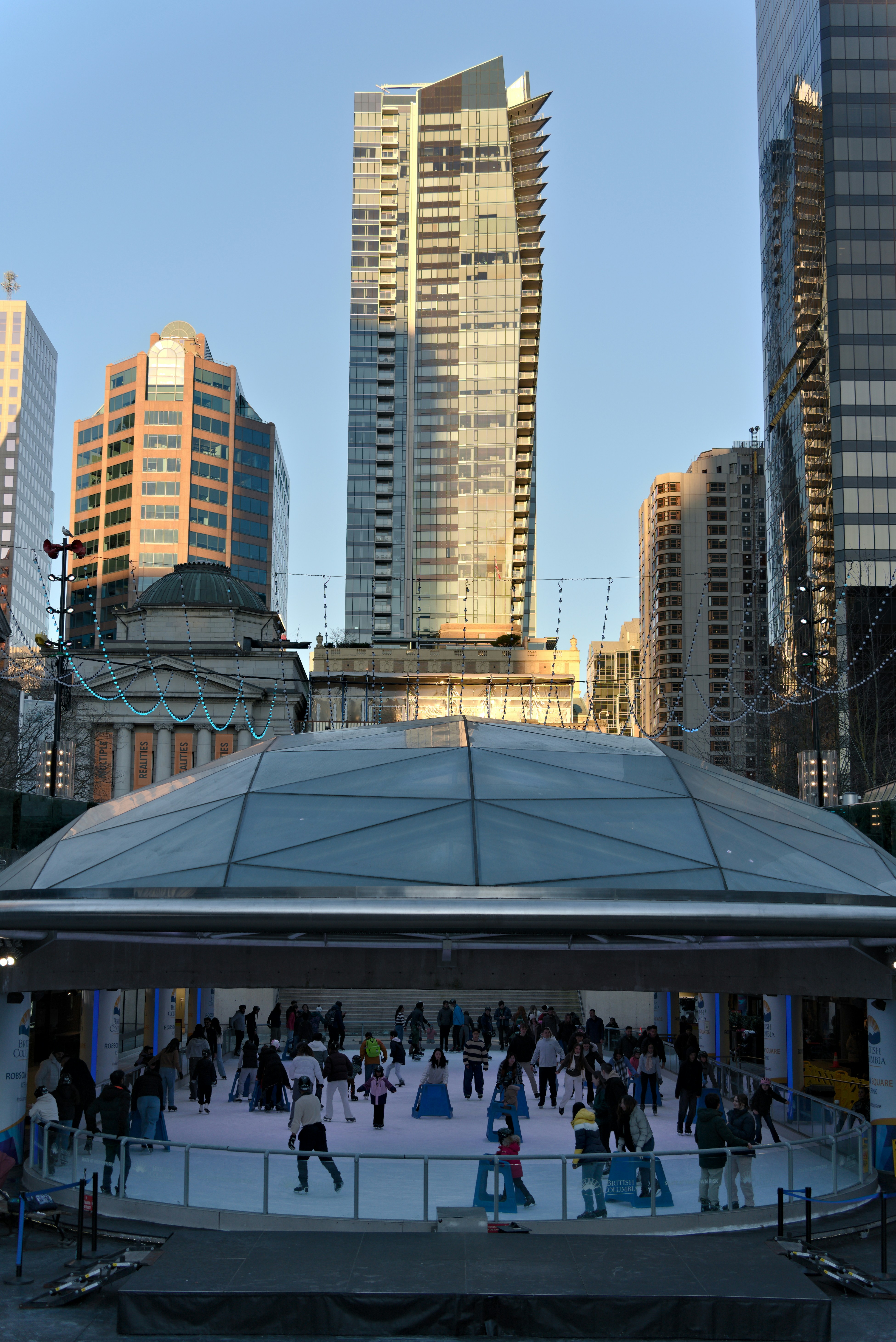 Skyscraper Ridge Over the Ice: An Urban Ice Rink Beneath Glass Canopy