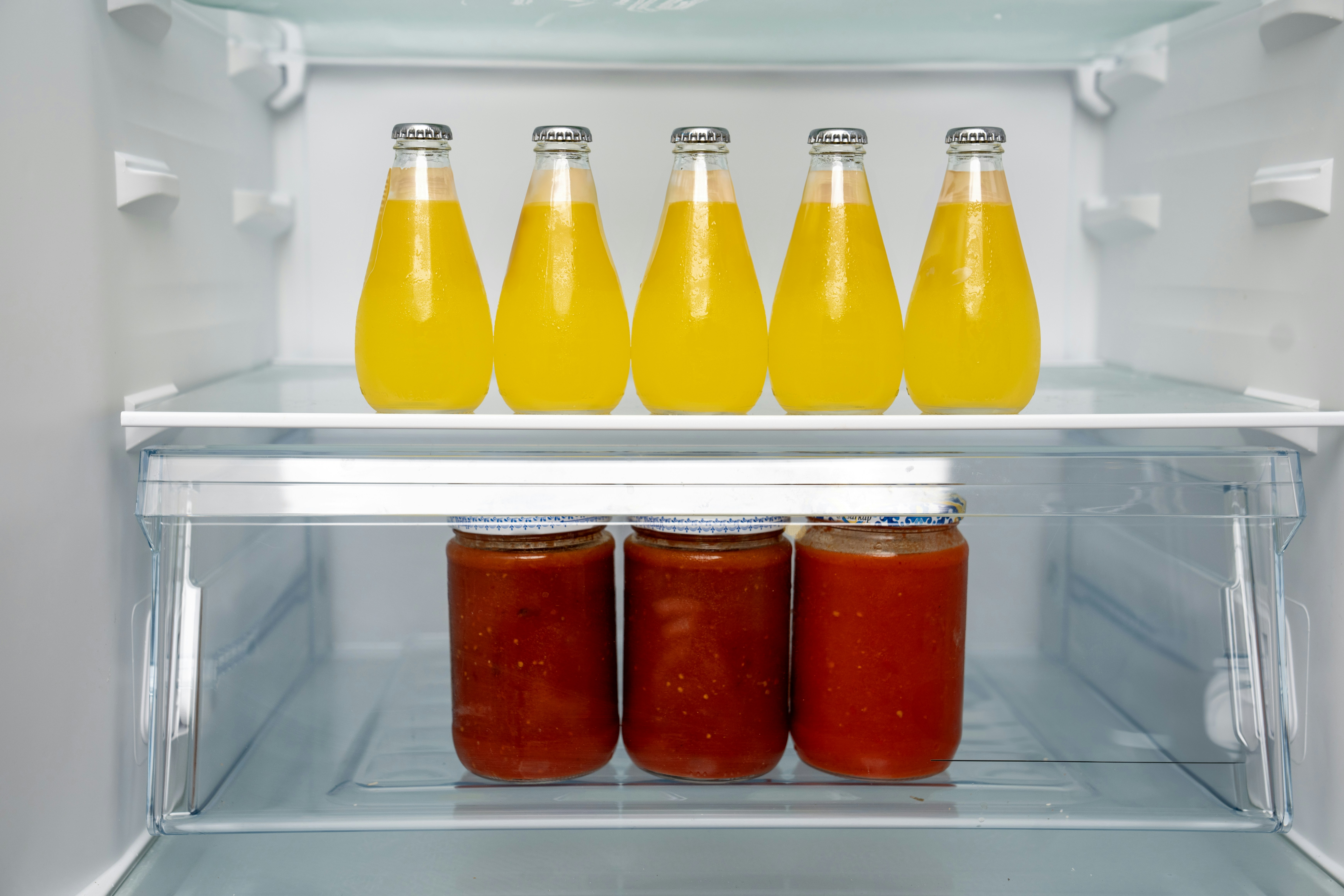 A refrigerator filled with lots of bottles of juice photo – Free Food ...