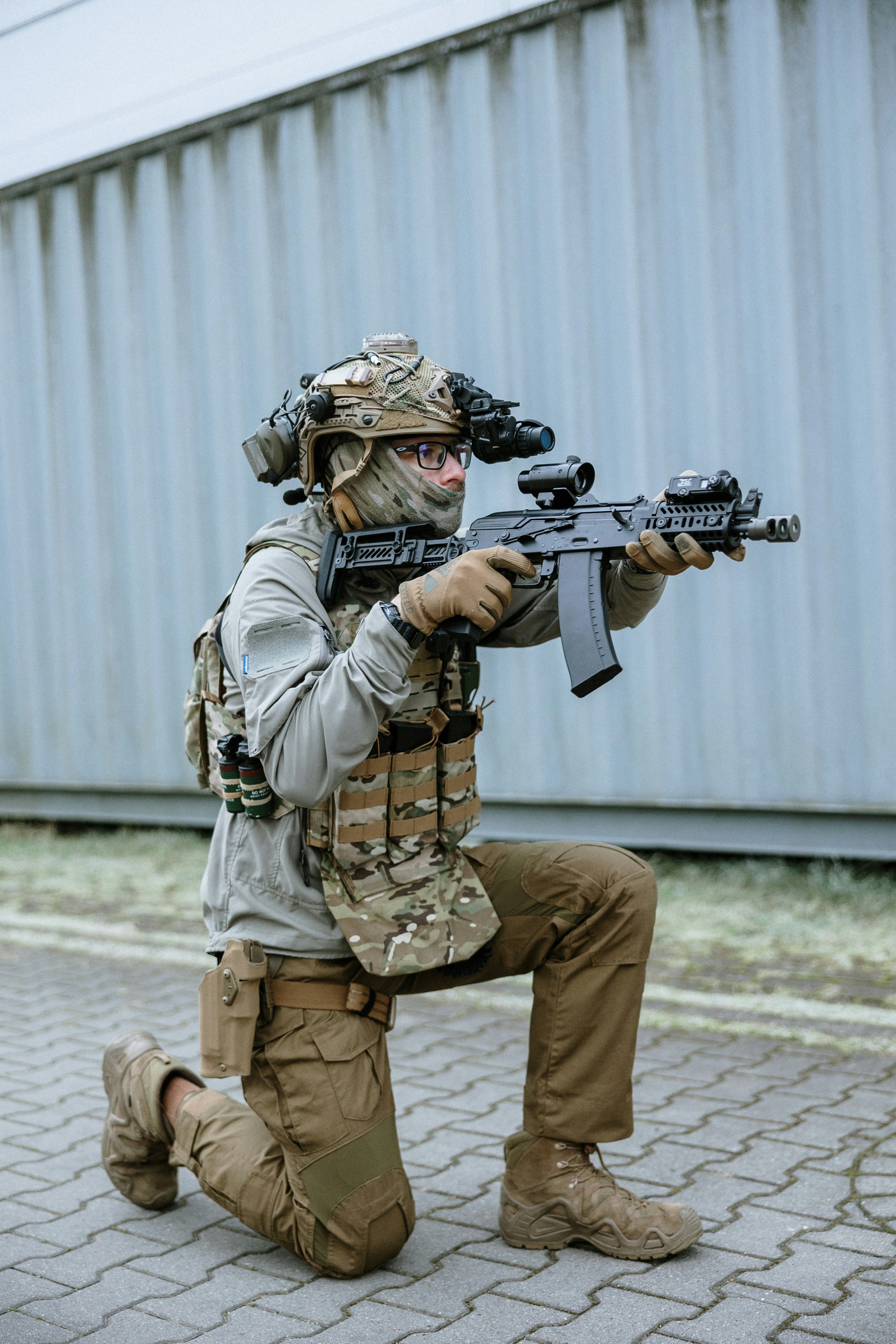 A man kneeling down with a rifle in his hand photo – Free Gun Image on ...