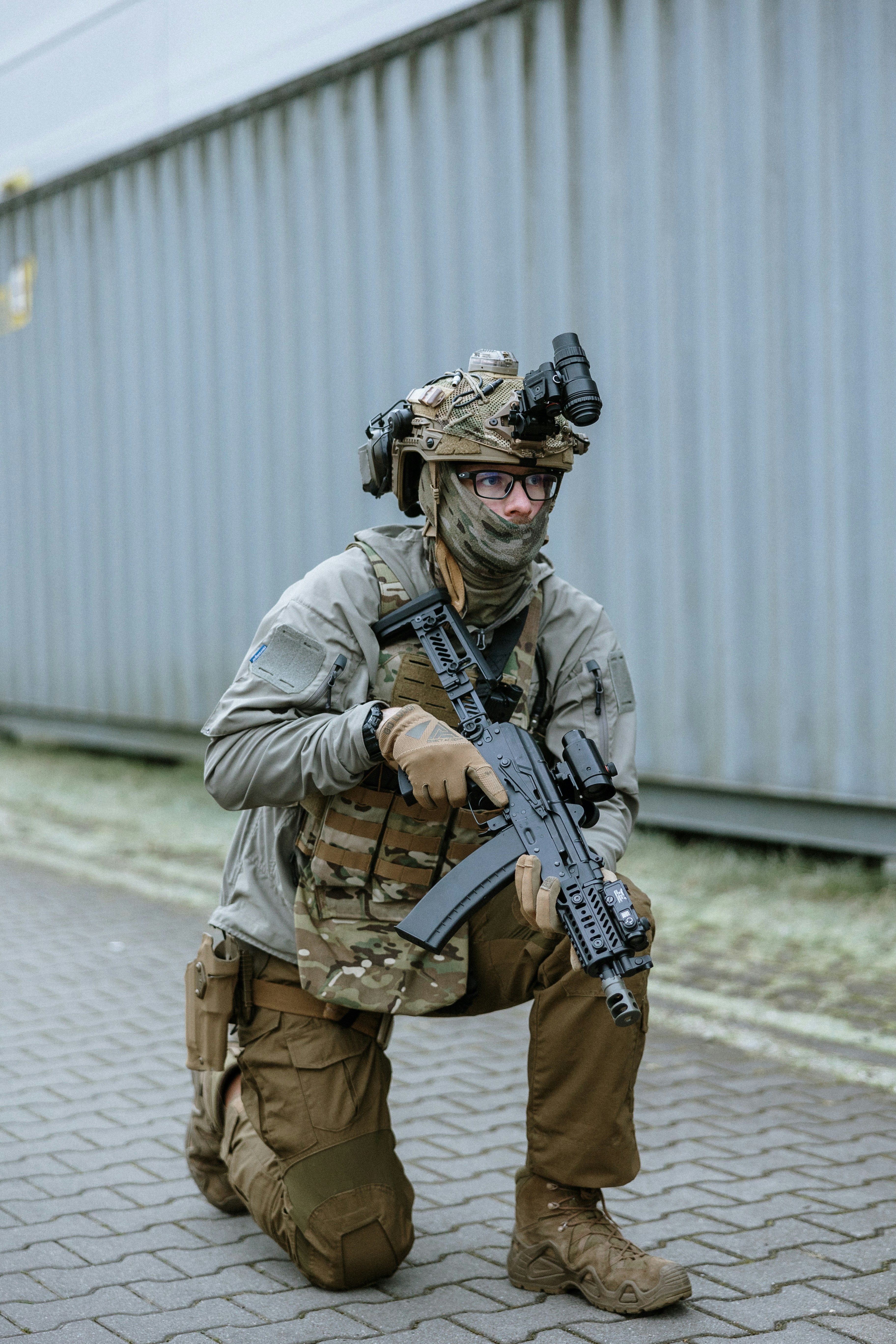 A man kneeling down with a gun in his hand photo – Free Gun Image on ...
