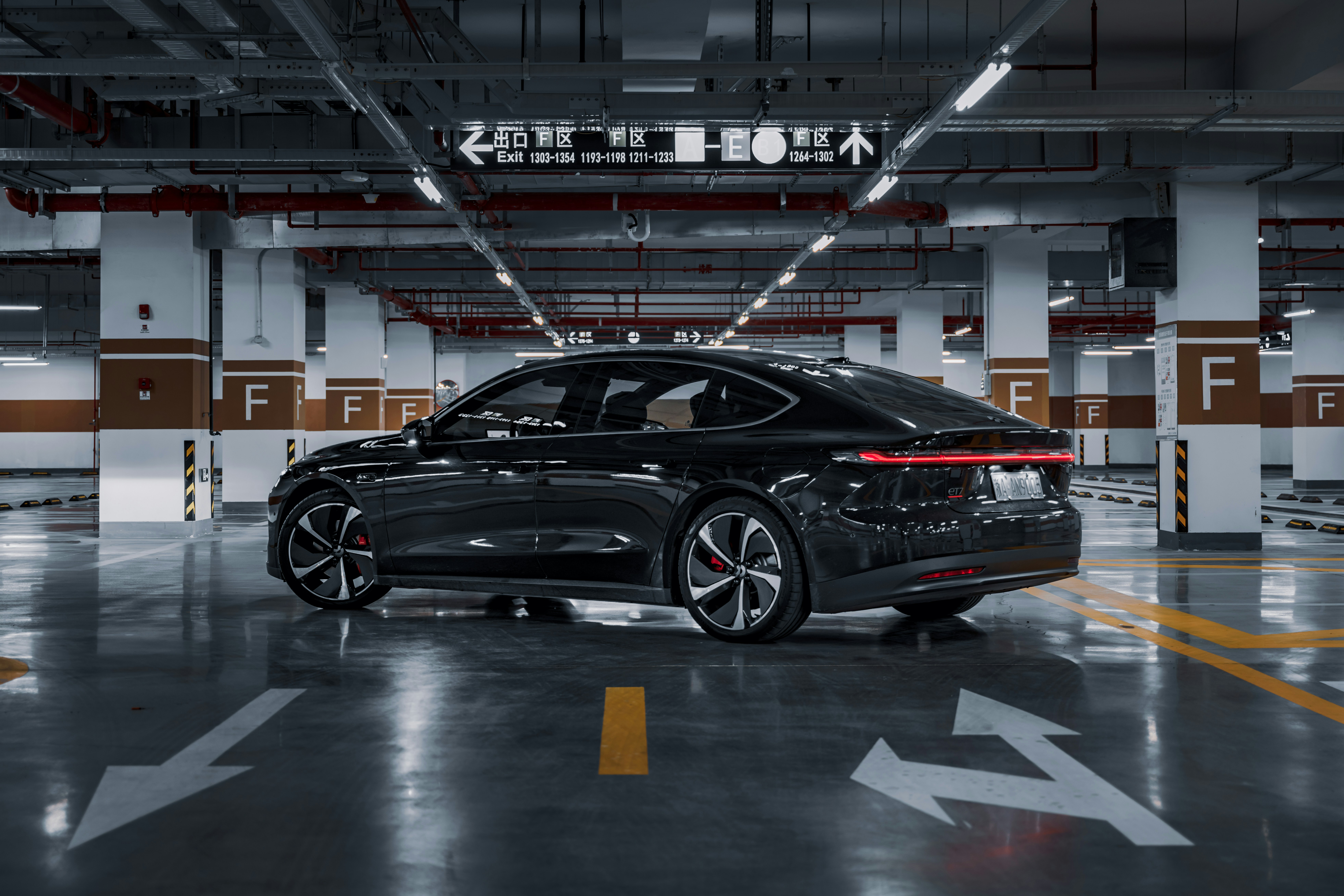 A black car parked in a parking garage photo – Free Nio et7 Image on ...