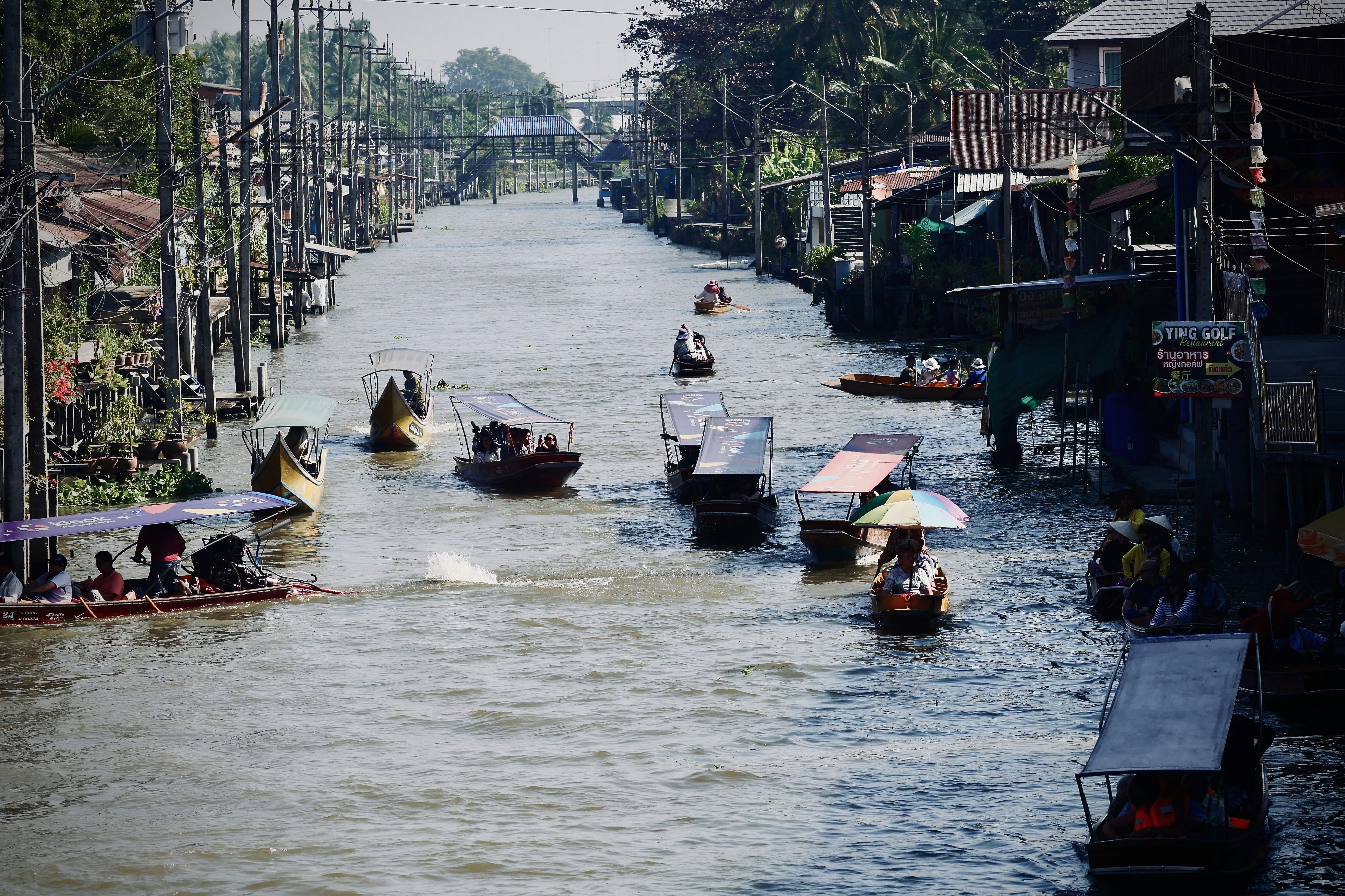 A group of people riding boats down a river photo – Free Floating ...