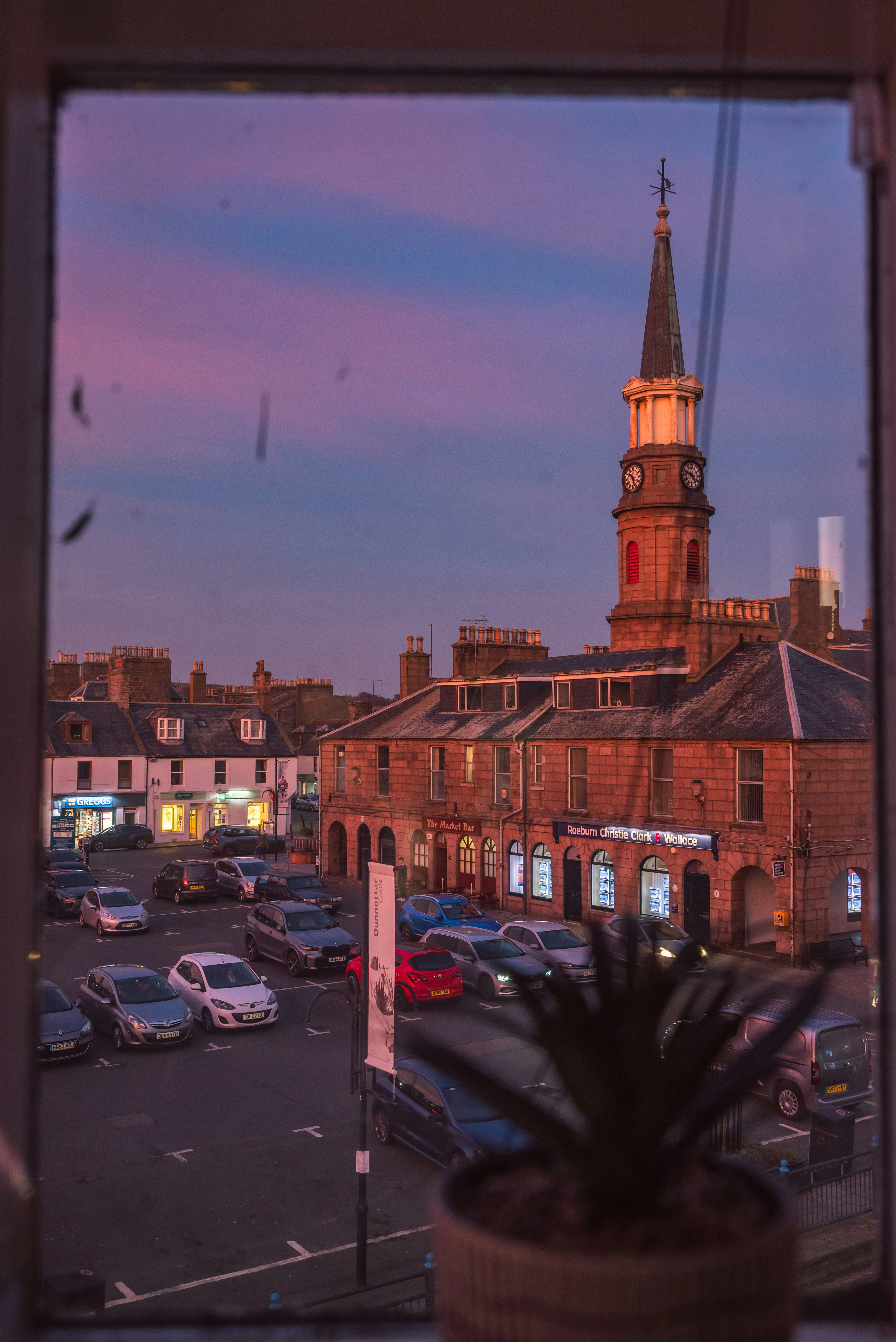 A view of a clock tower through a window photo – Free Stonehaven Image ...