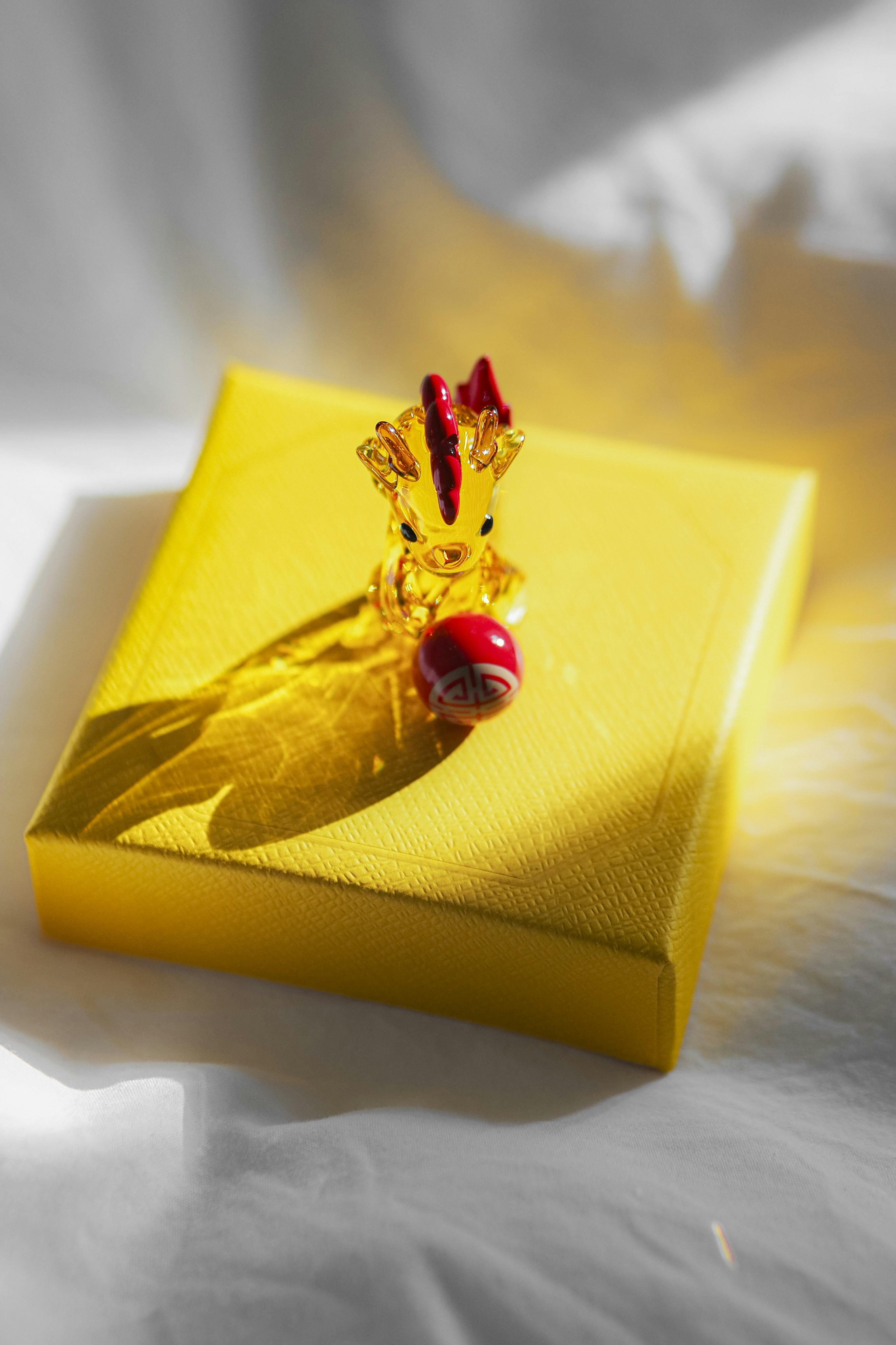 A yellow object with a red object on top of it photo – Free Jewelry ...