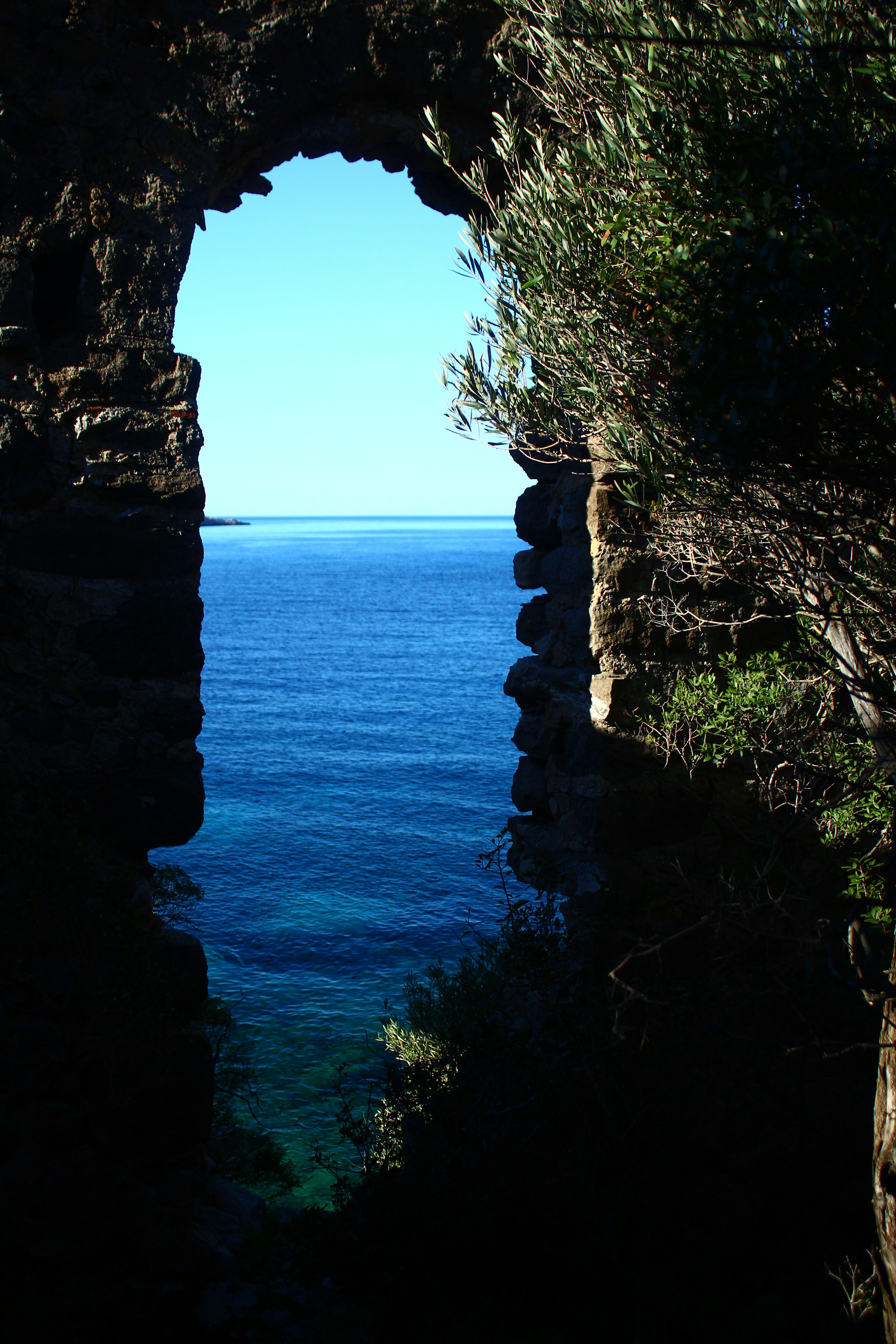 Sea Through a Stone Window: Turquoise Waters Framed by a Coastal Arch