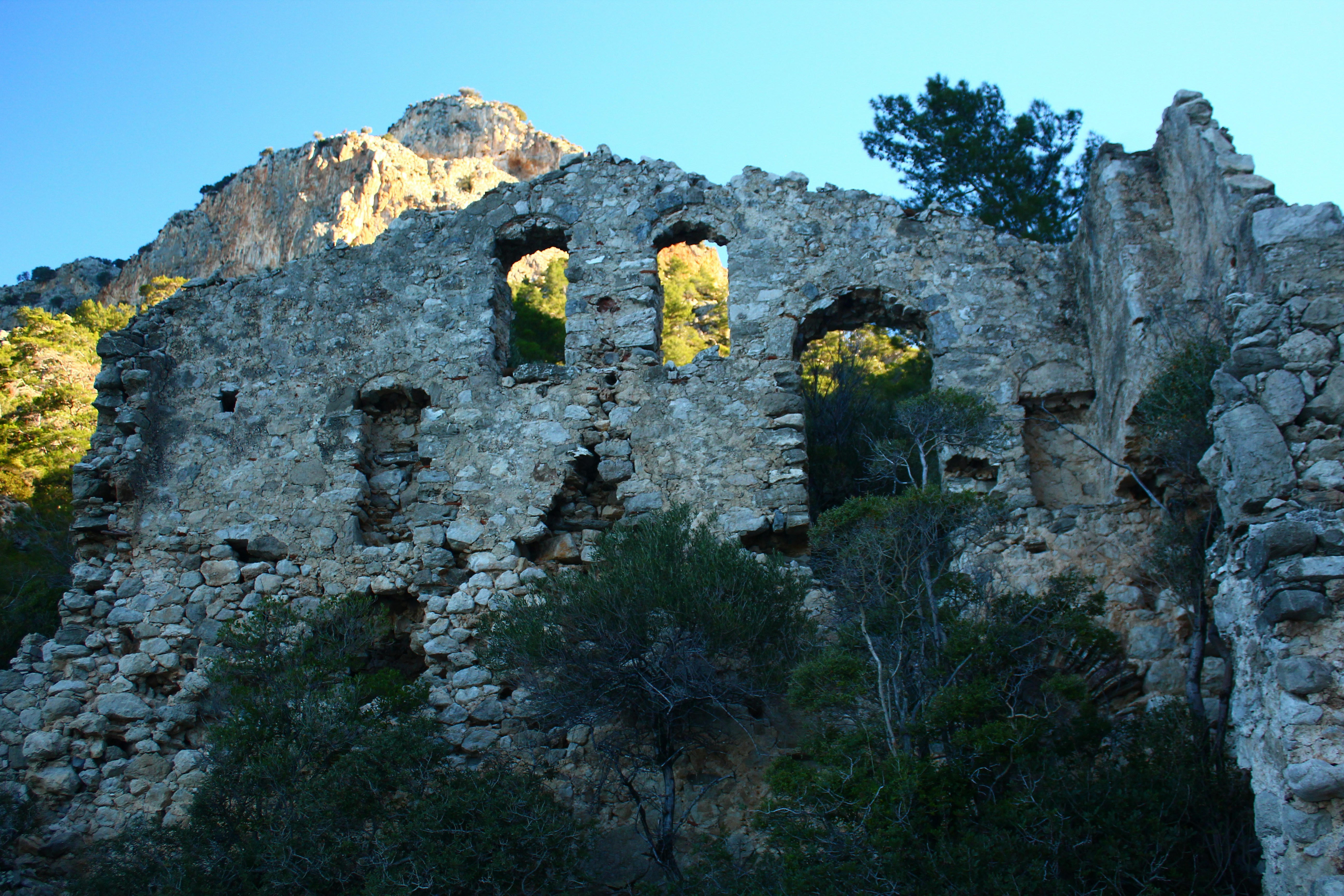 Three Stone Arches Framed by Mountain Light