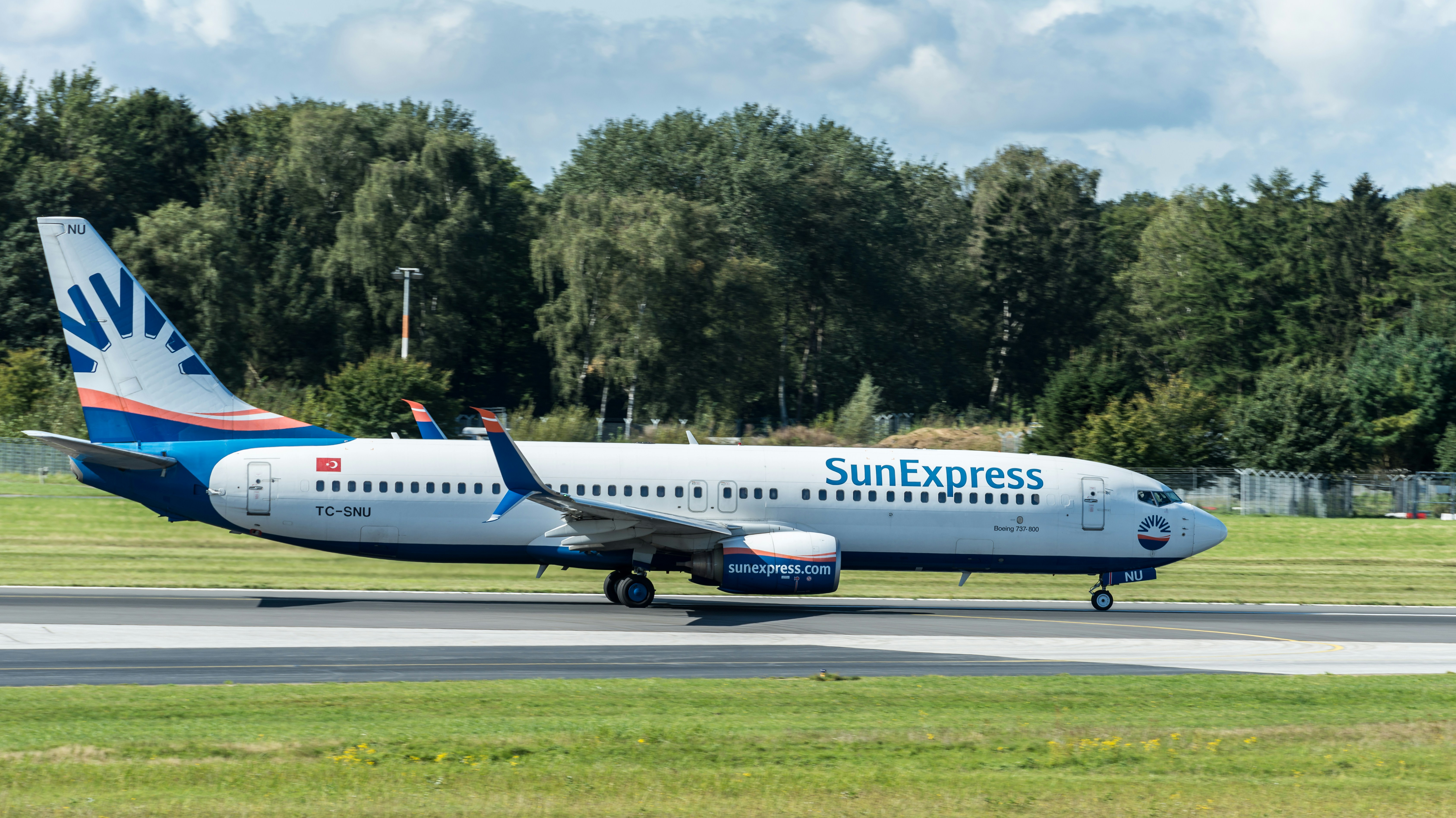 A large passenger jet sitting on top of an airport runway photo – Free ...