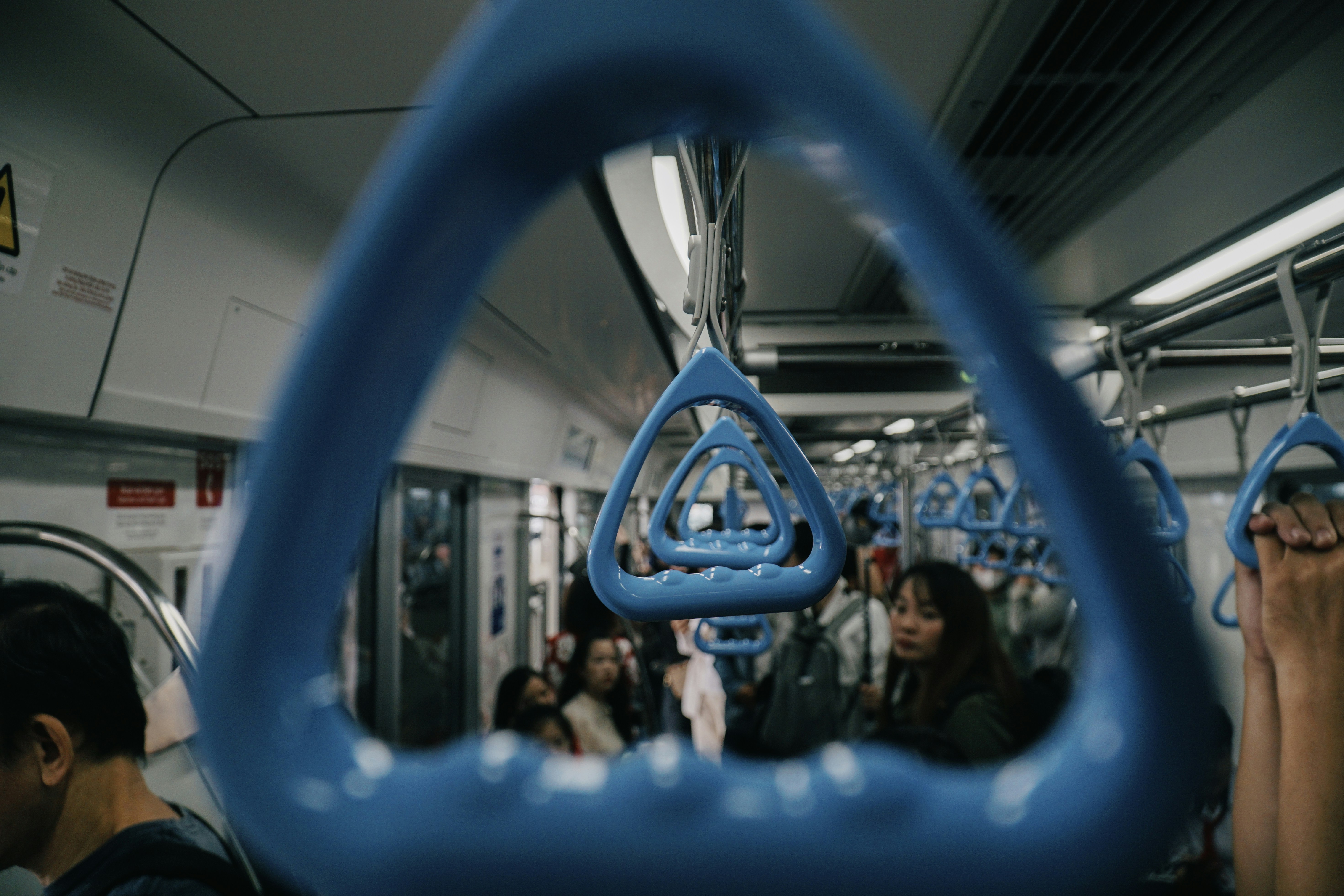 A group of people riding on a train next to each other photo – Free ...