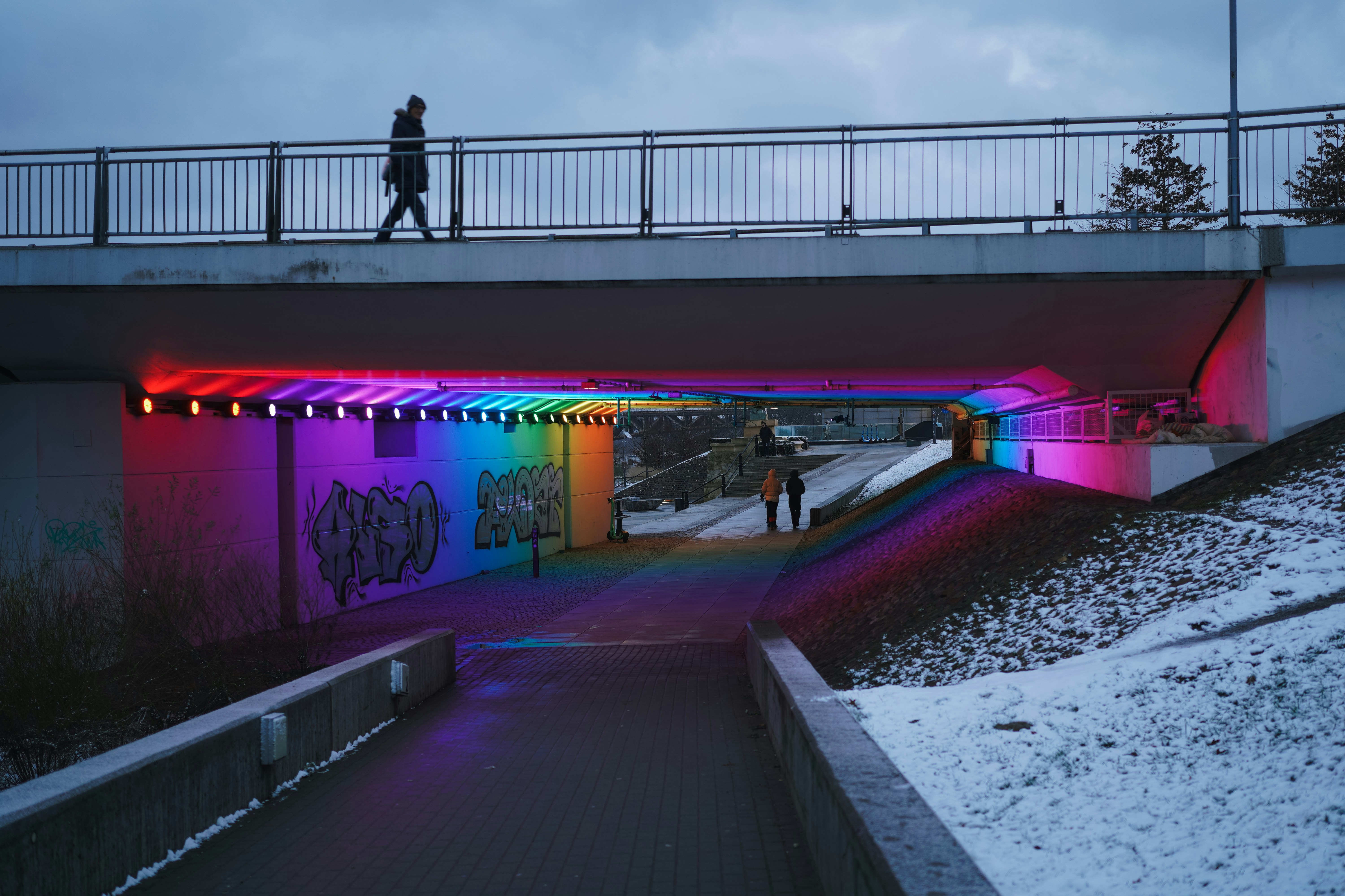 Rainbow Corridor Under the Bridge: Snow-Kissed Neon Path