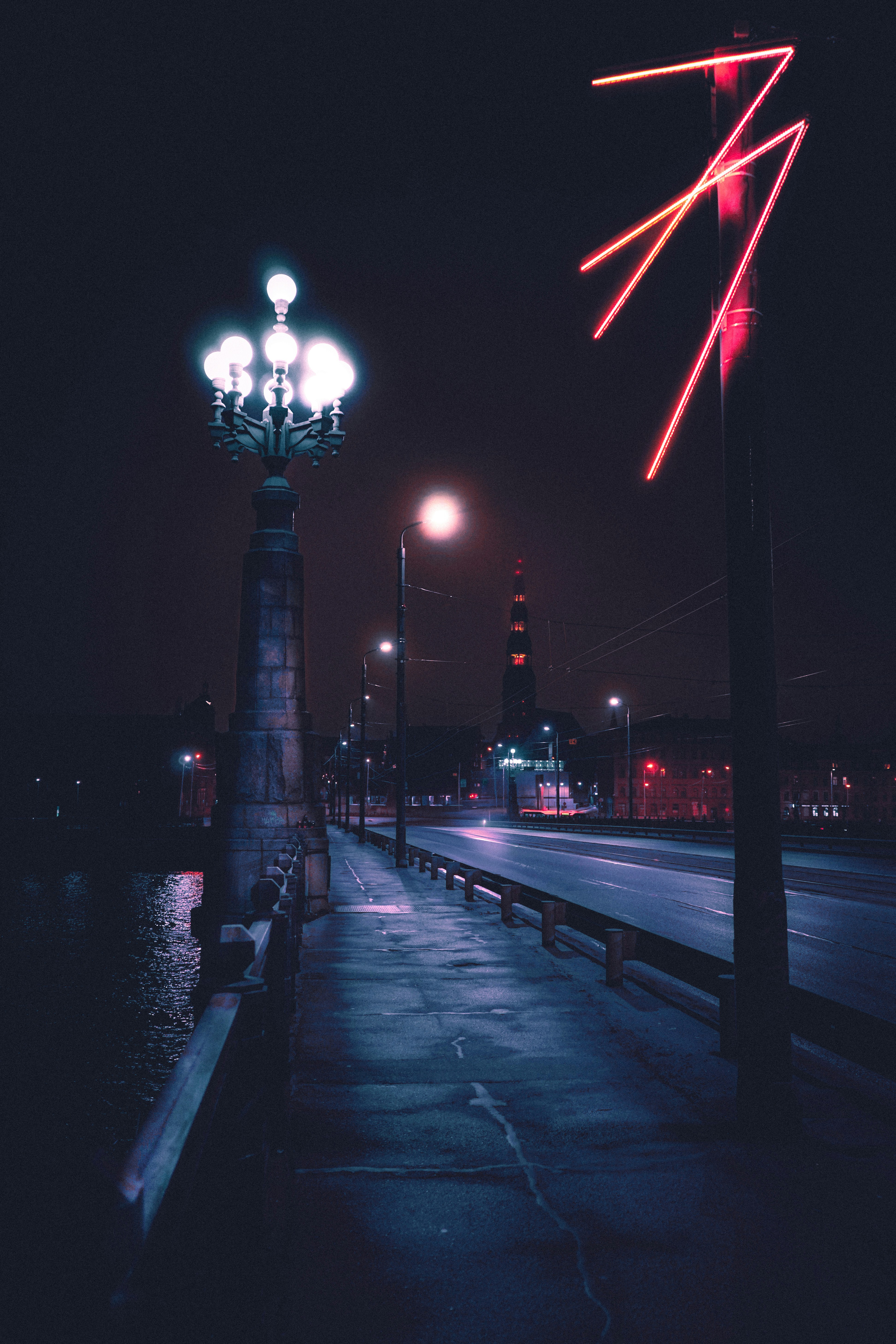 Lamplight Reverie: Neon Arcs Over a Quiet Riverside Promenade