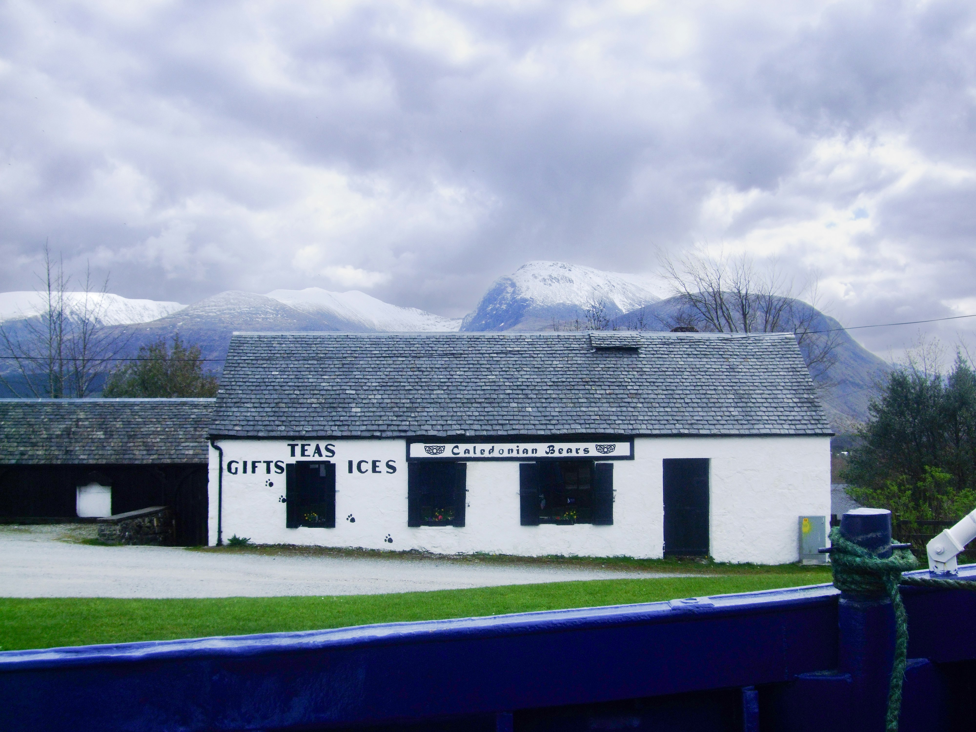A white building with a blue fence around it photo – Free Caledonian ...