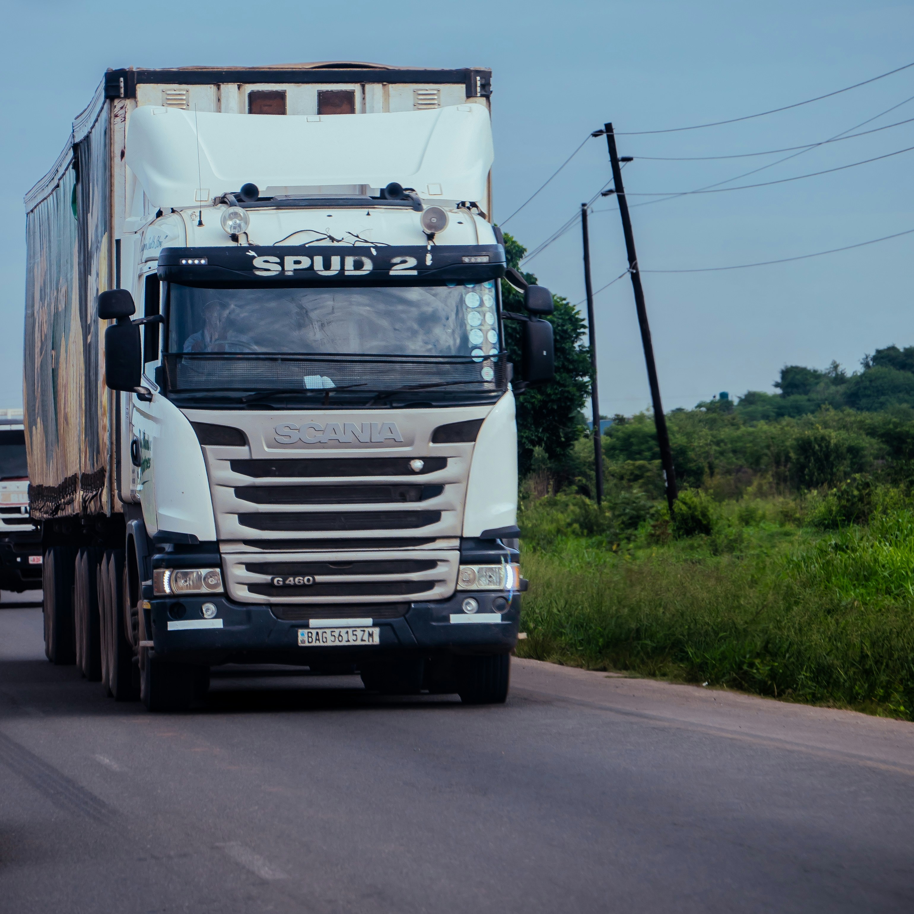 A couple of trucks driving down a road
