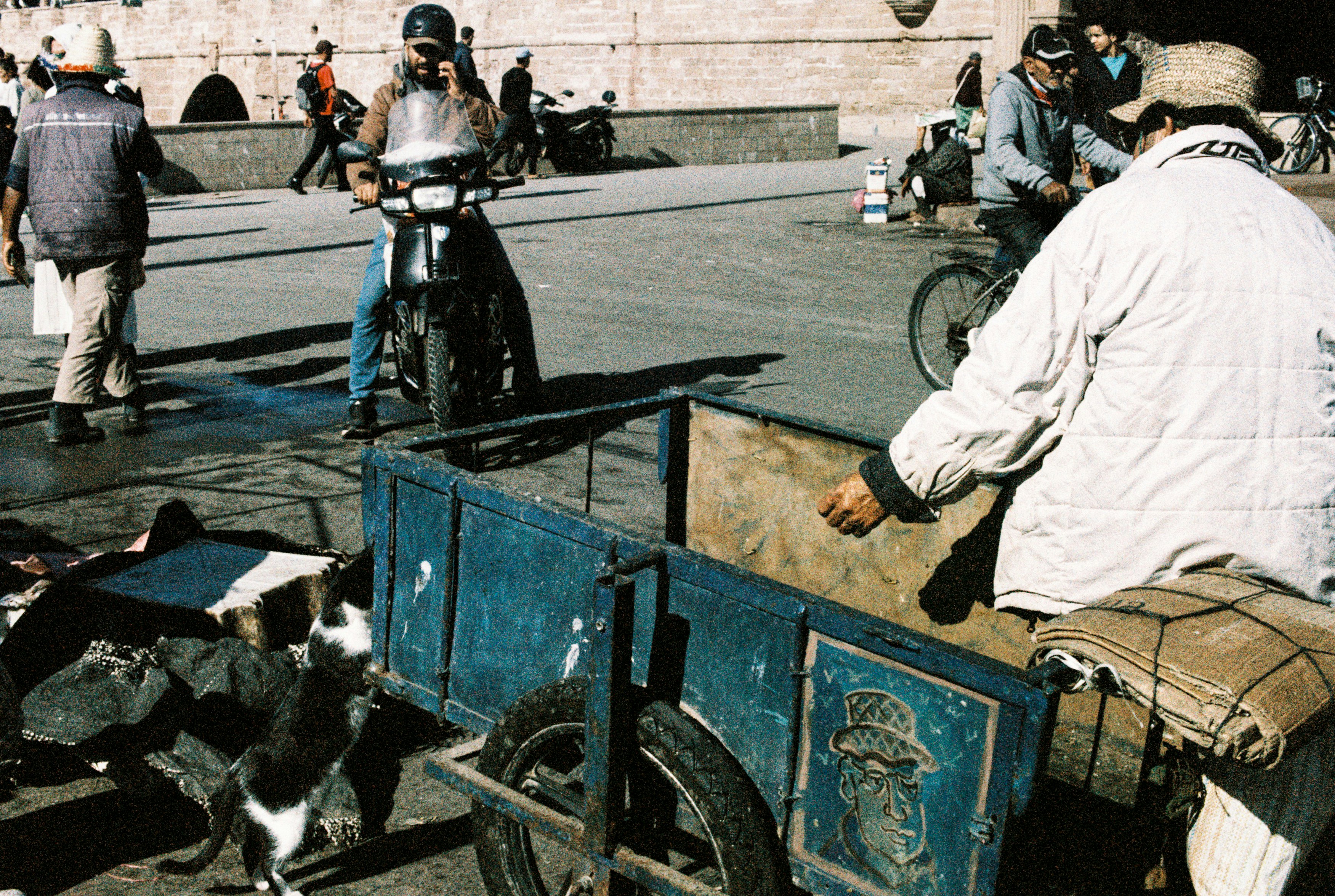 Rider in the Market Square: A Moment Framed by the Blue Cart