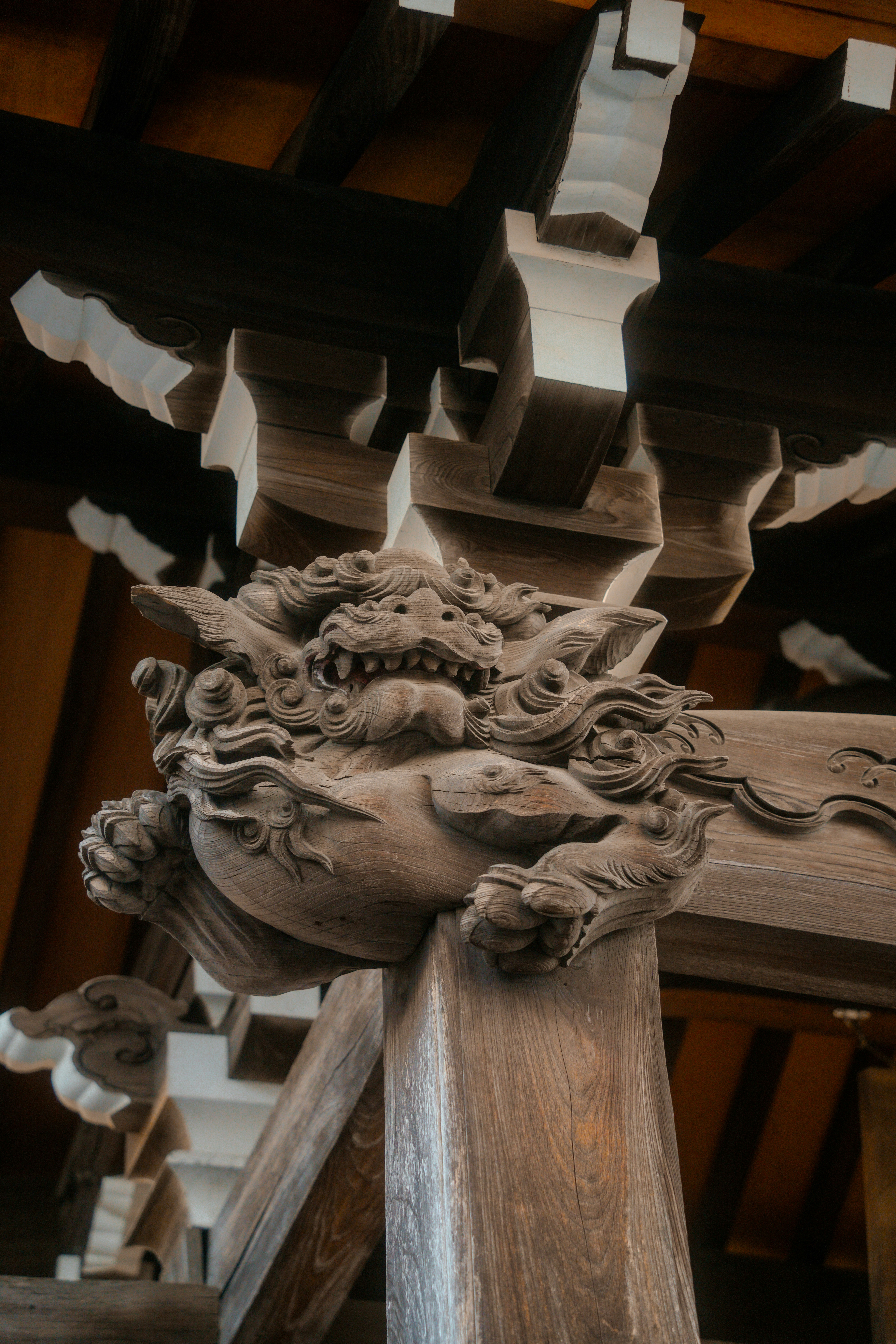 Dragon Guardian Carving Under Interlocking Timber Beams