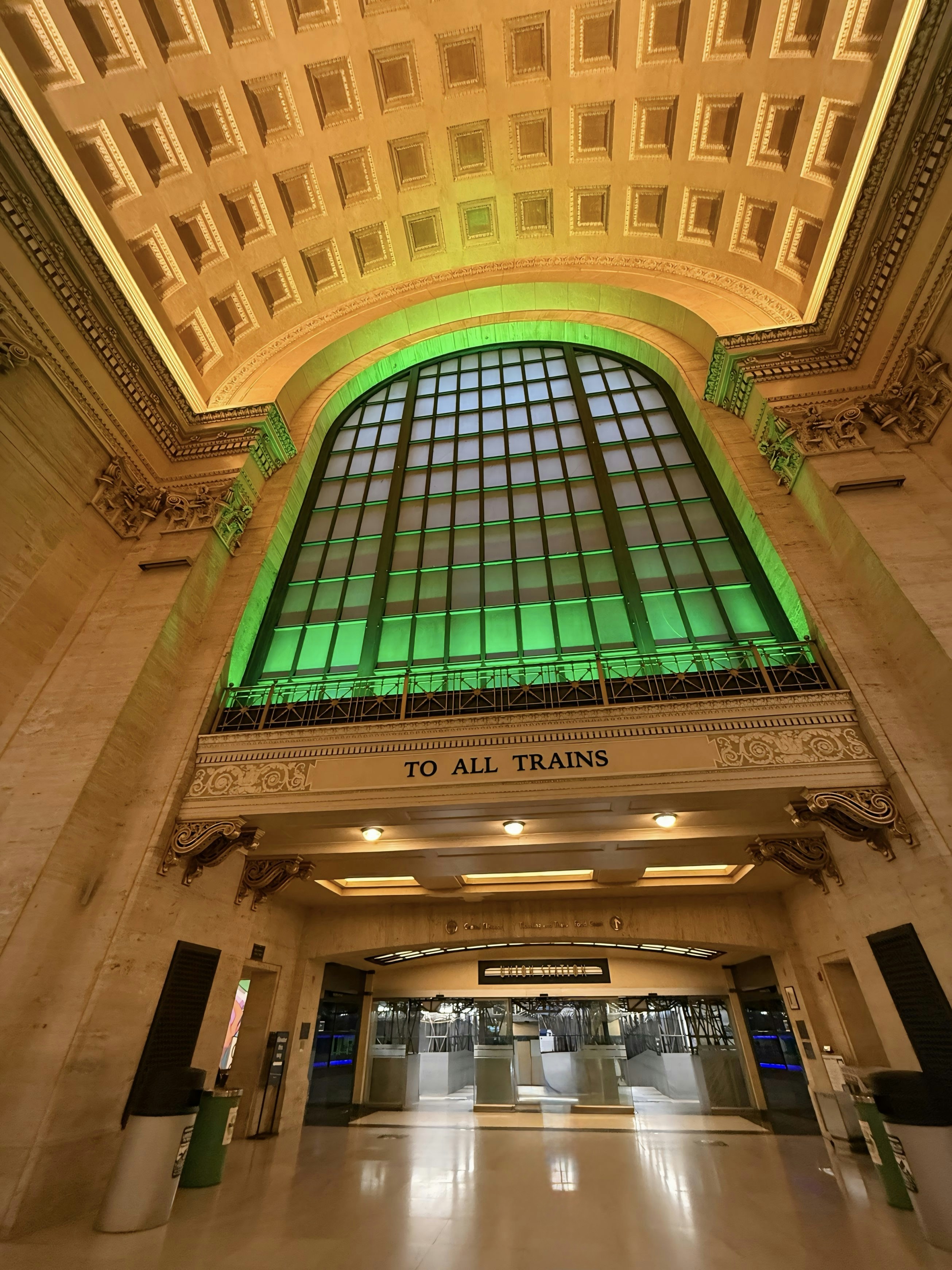 A very tall building with a big green window