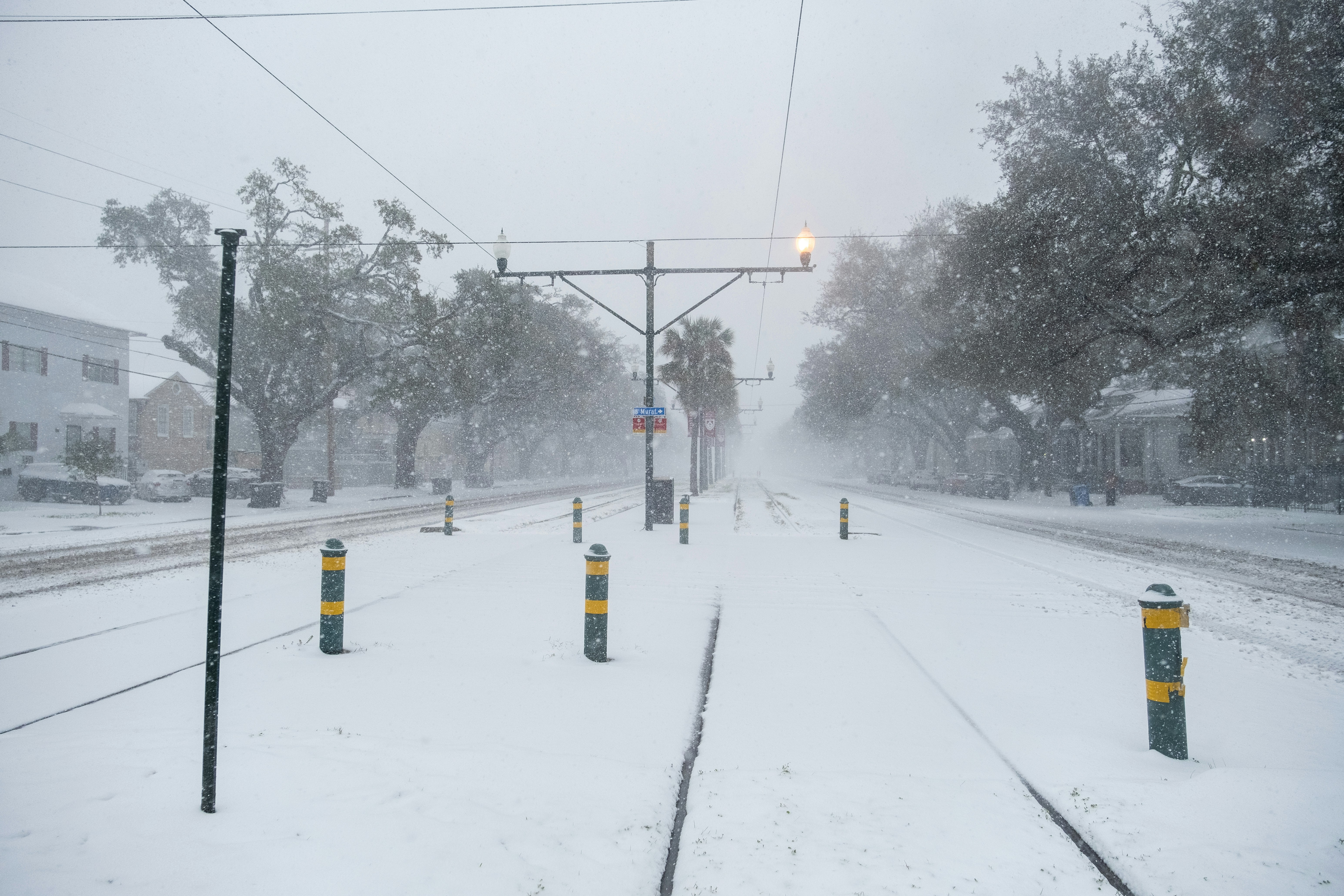 A snowy street with traffic lights and street signs photo – Free New ...