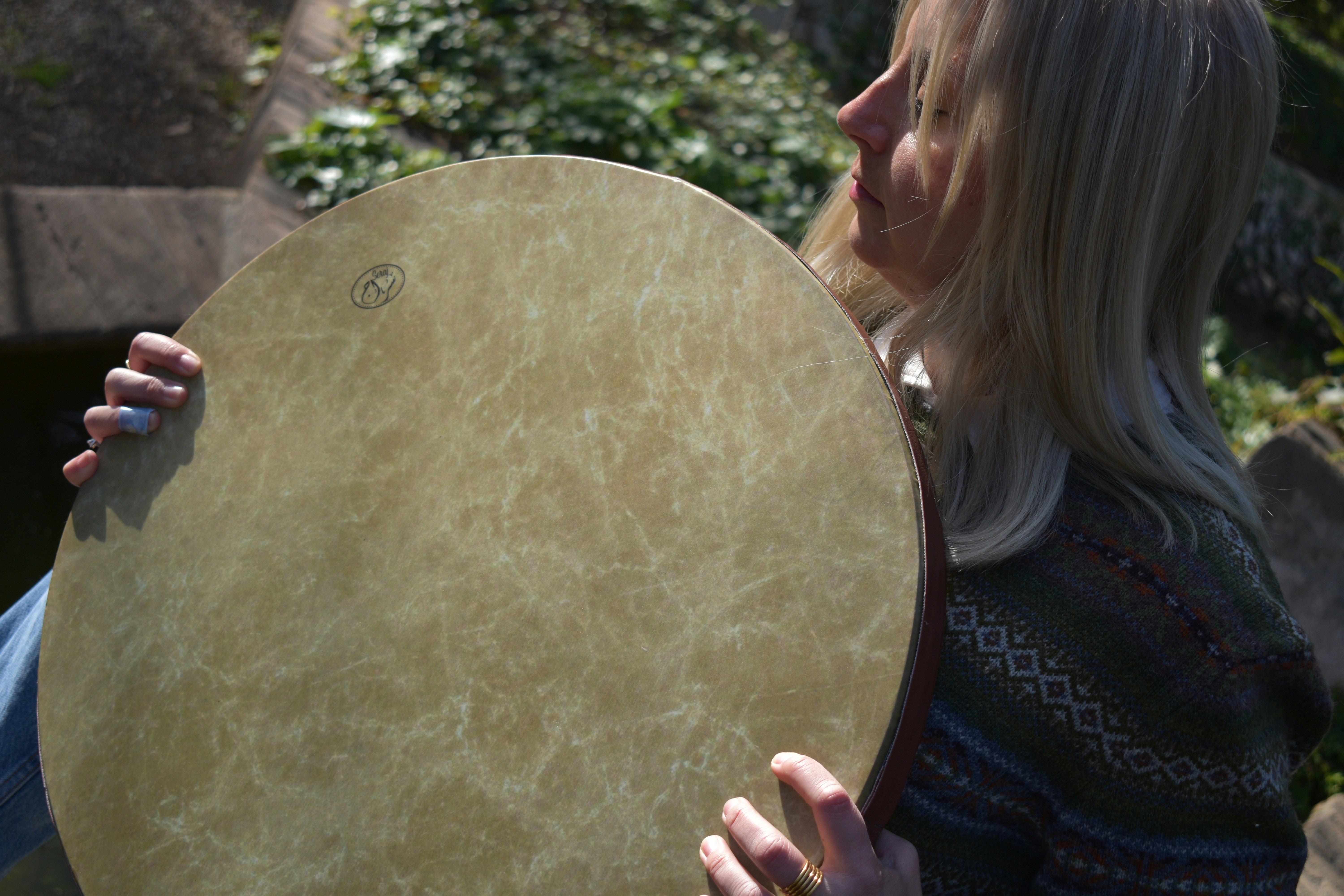 Holding the Beat: A Drummed Portrait Hidden in the Shadowed Glass