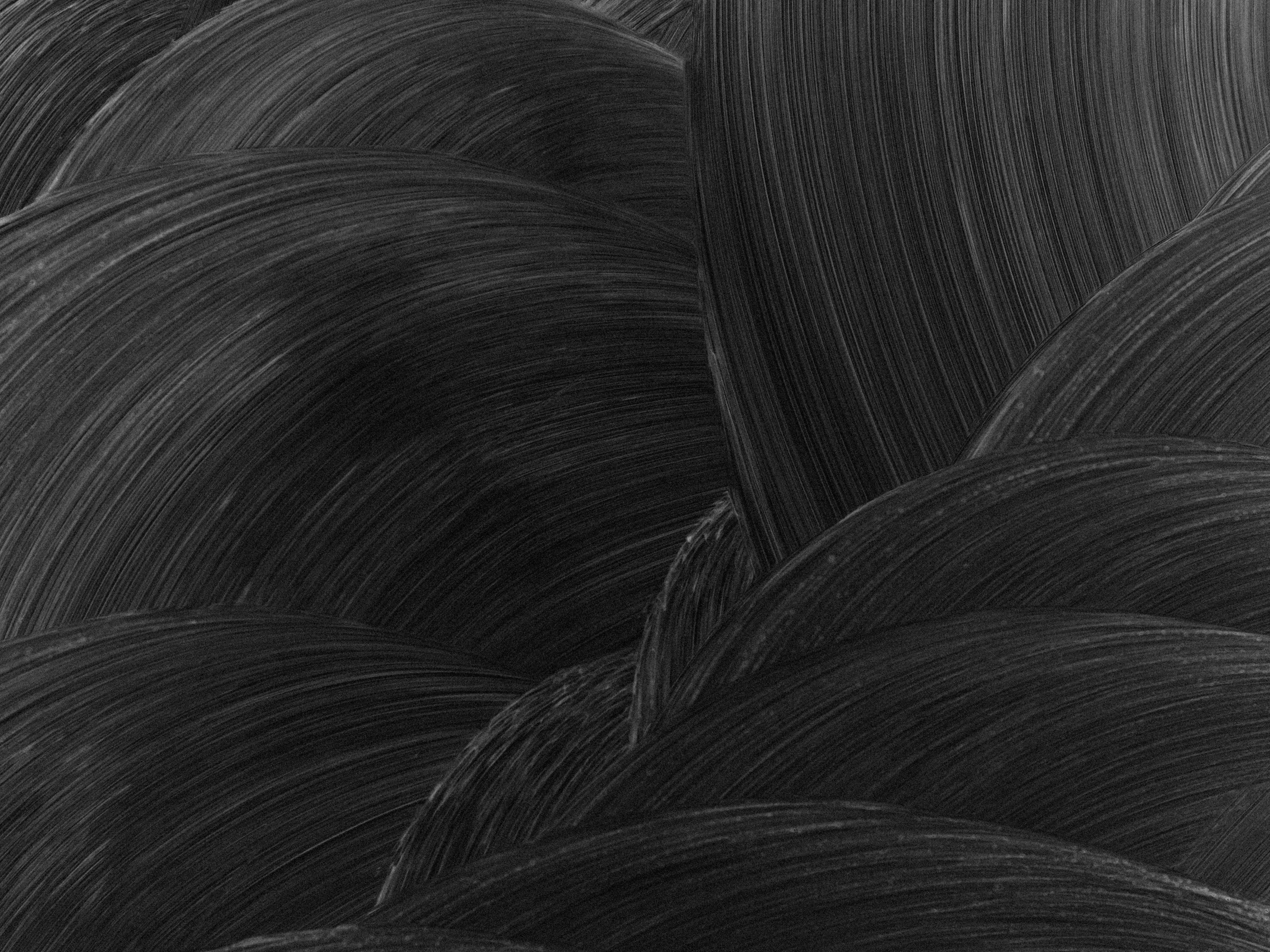 Abstract photograph of a window background texture painted in deep black, with scraping movements. Experimental and artistic photography.