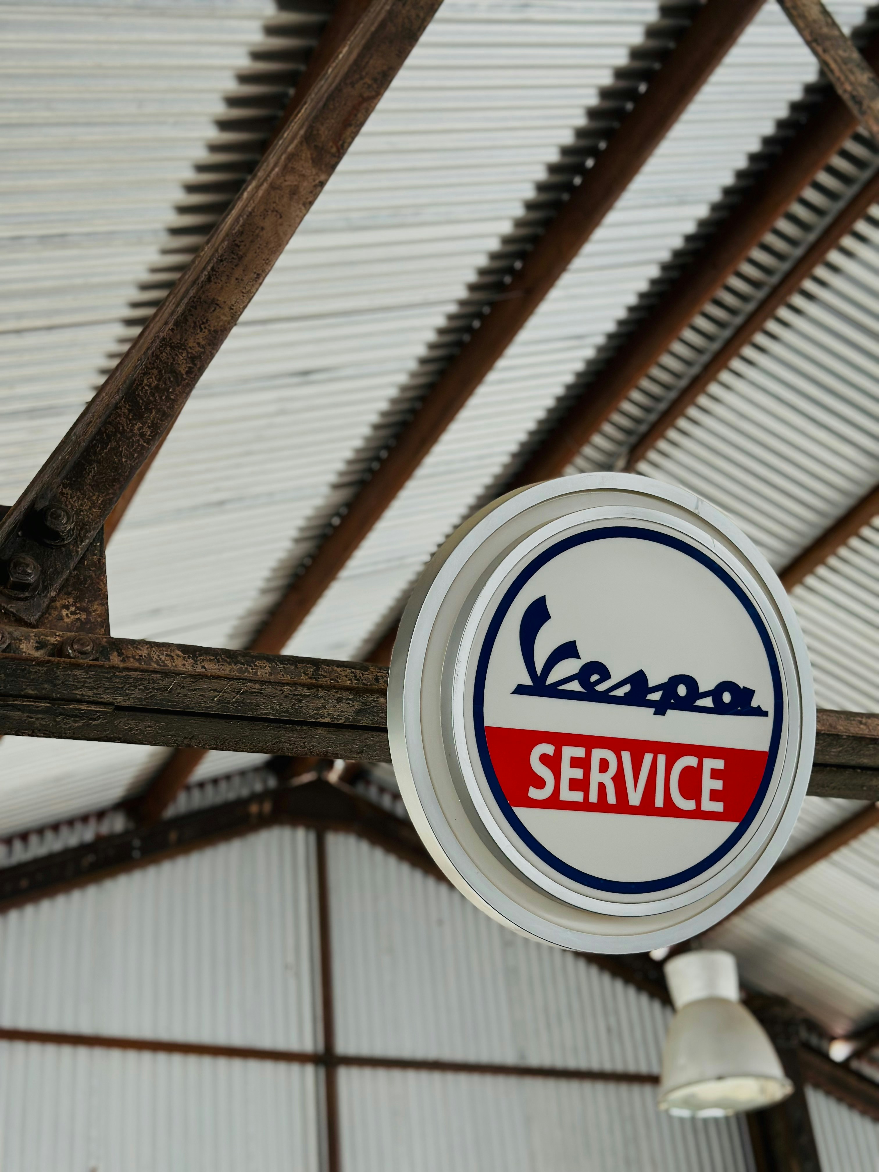 A service sign hanging from the ceiling of a building photo – Free Logo ...