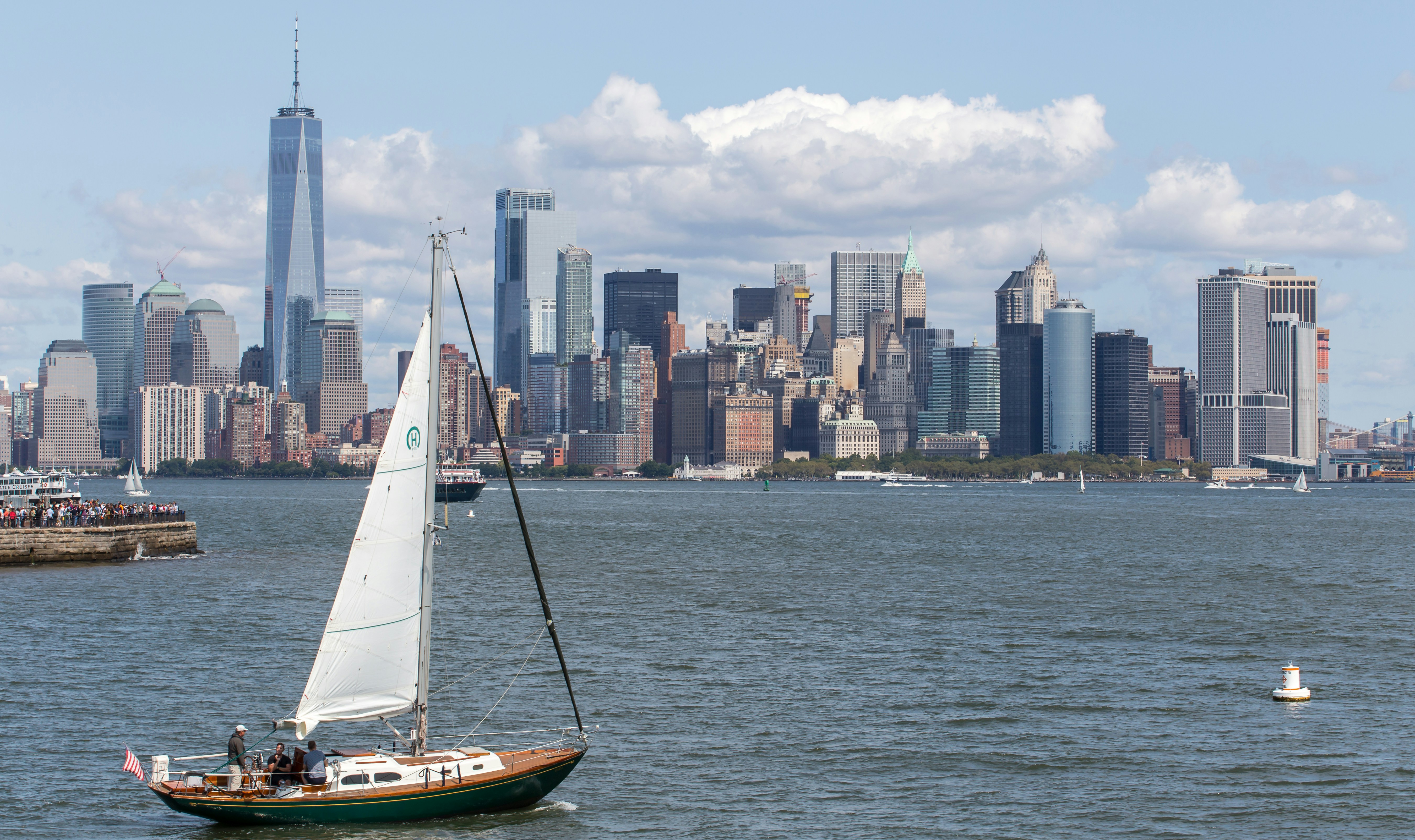 Sailboat at the Edge of Manhattan: Quiet Wake, Looming Skyline