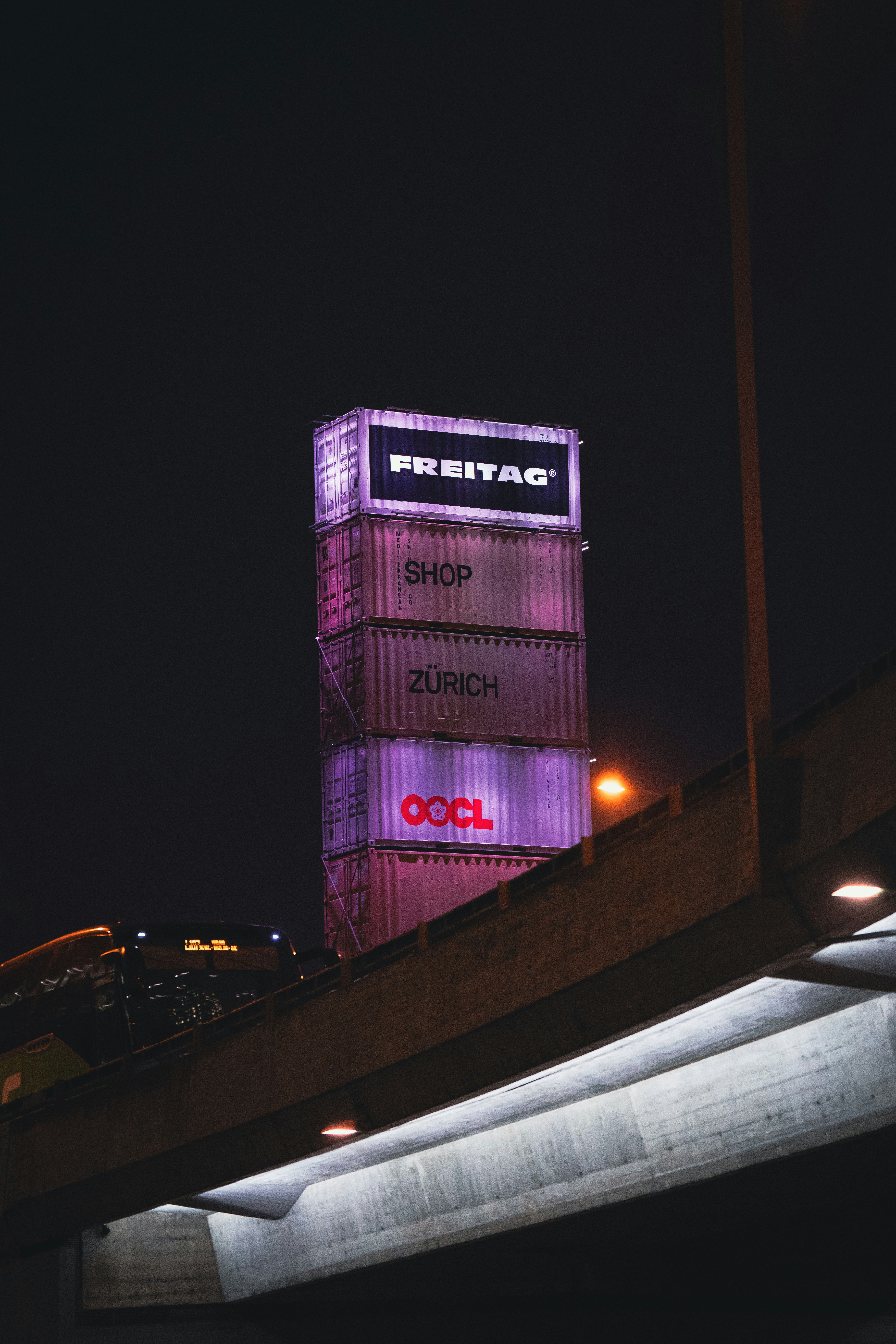 A tall building with a lit up sign on it's side photo – Free ...
