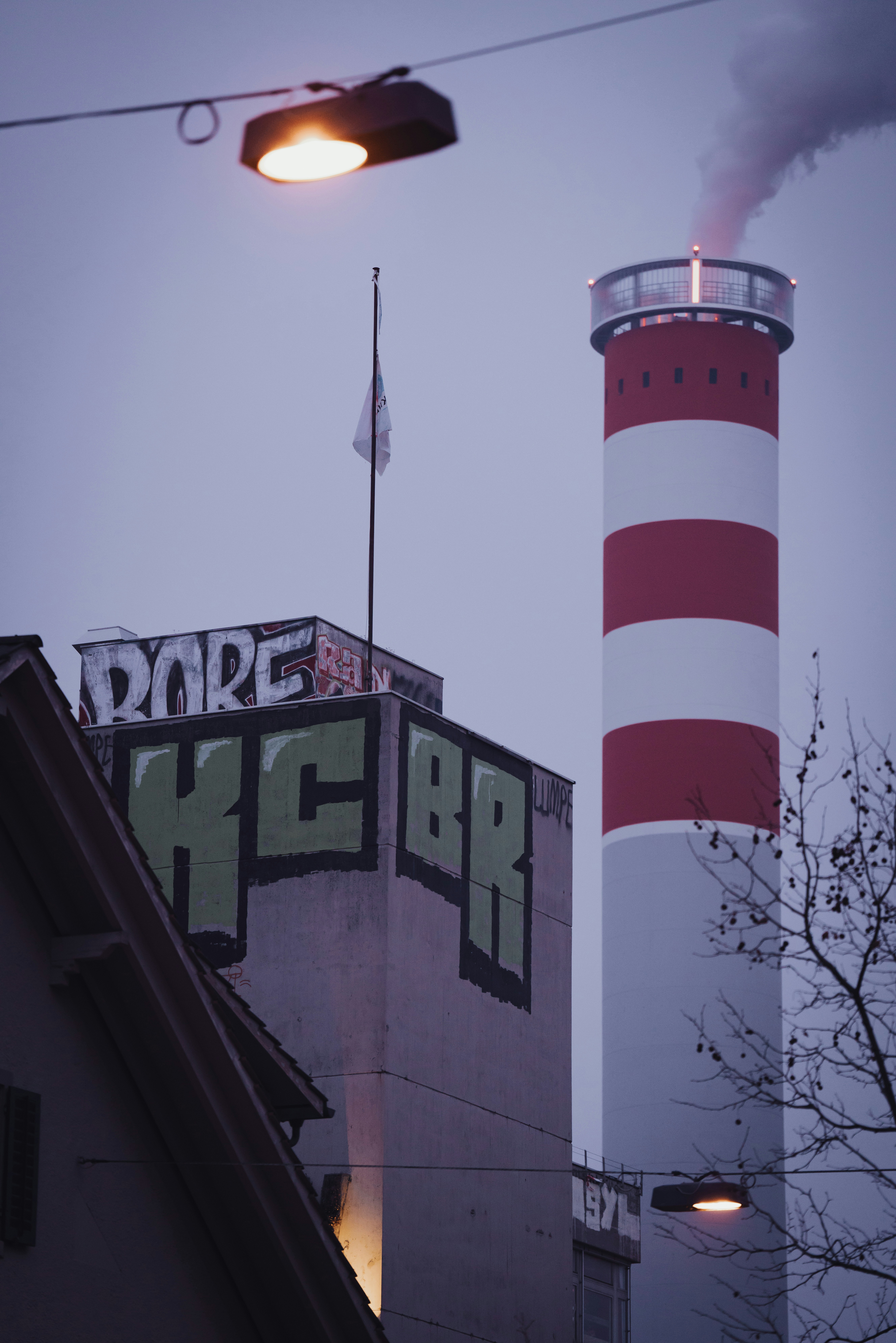 A smokestack emits from the top of a building photo – Free Building ...