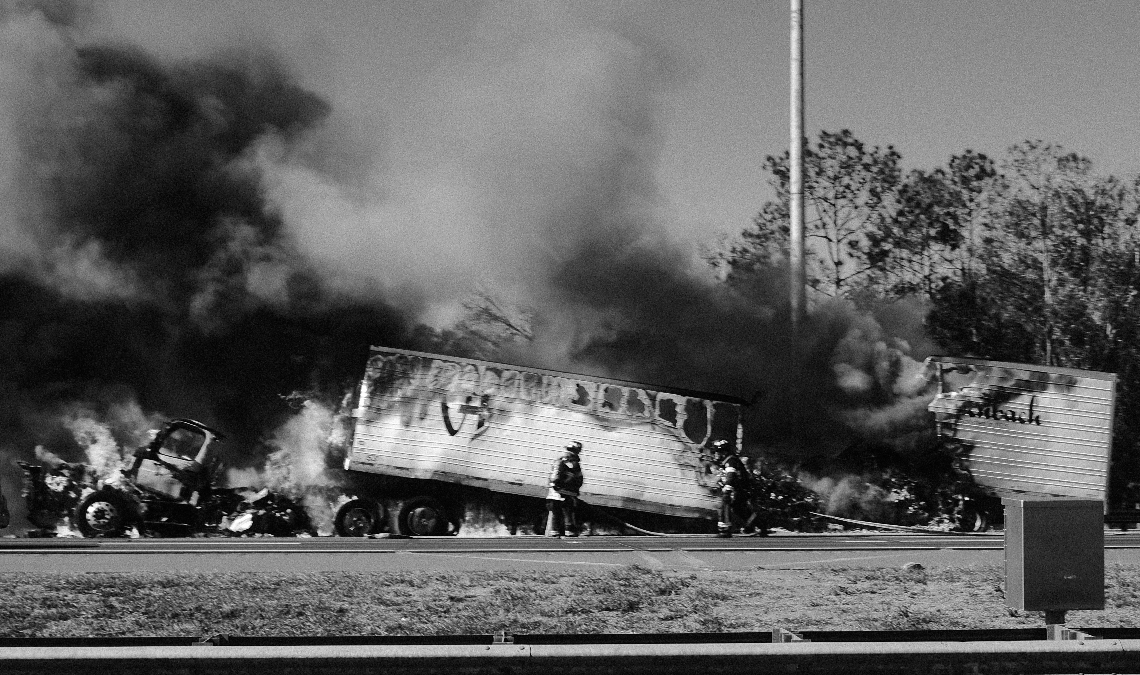 Interstate Inferno: Freight Trailer Ablaze and Smoke on the Horizon
