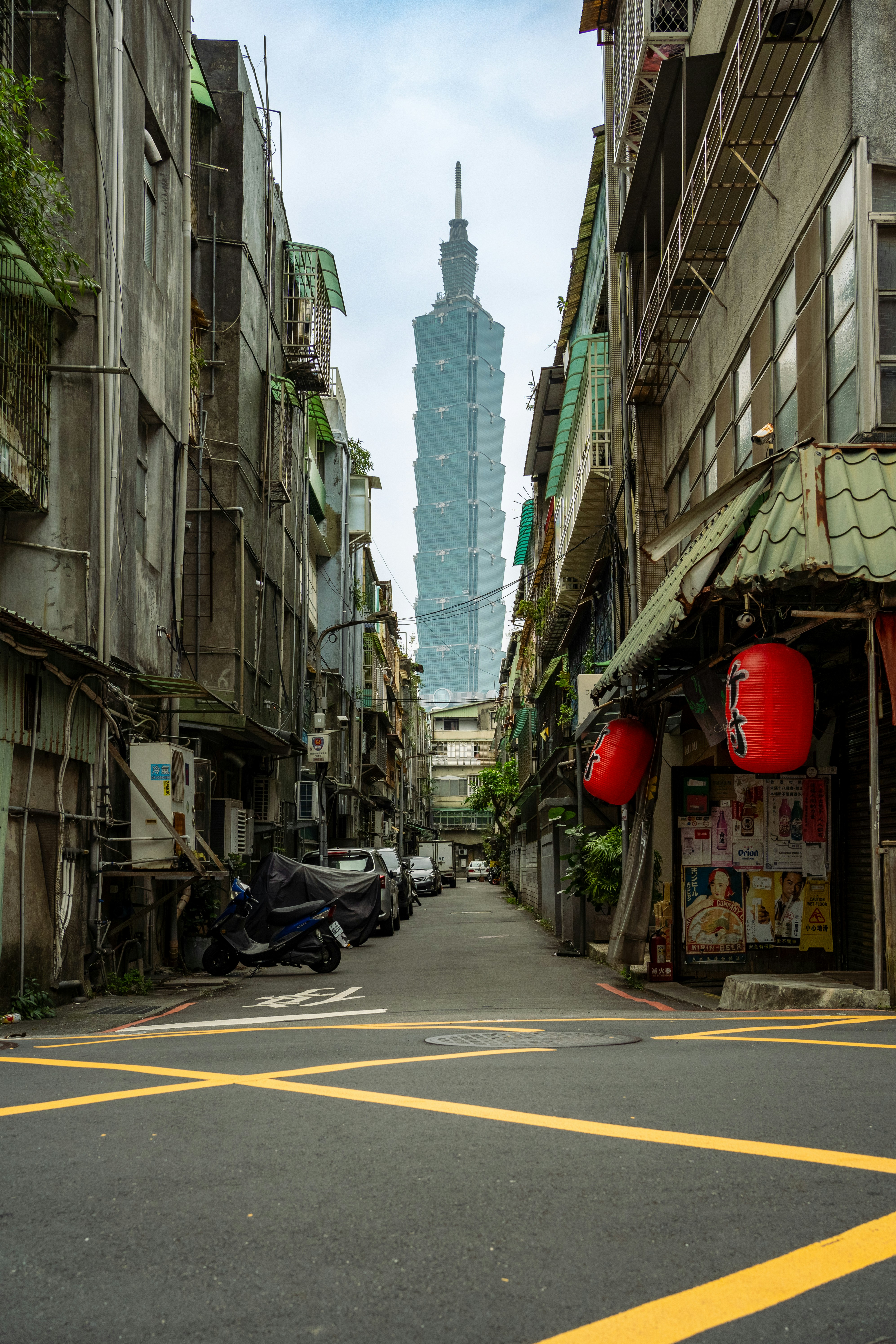 A narrow street with a tall building in the background