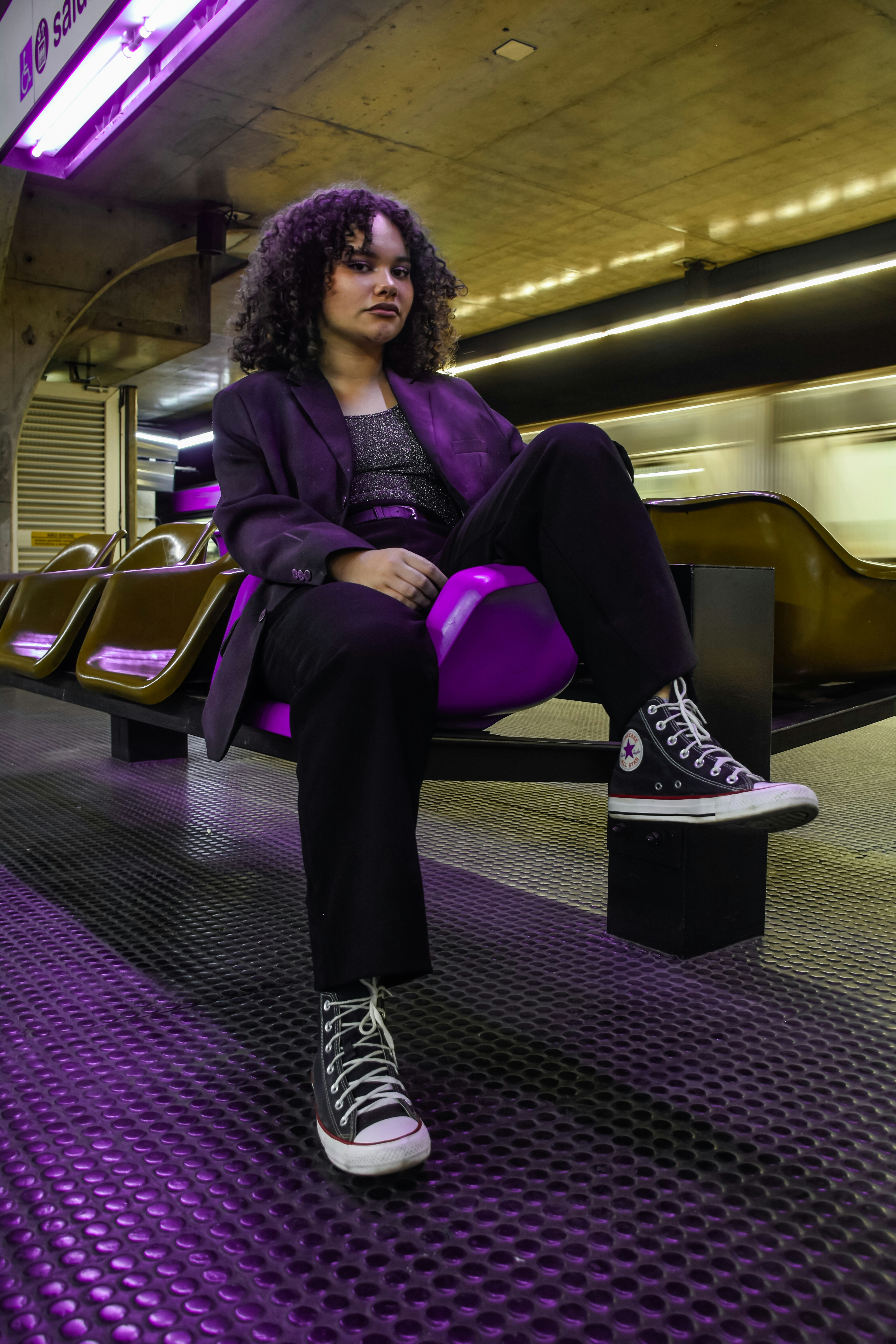 Purple Hour on the Platform: A Portrait Bathed in Neon Subway Light