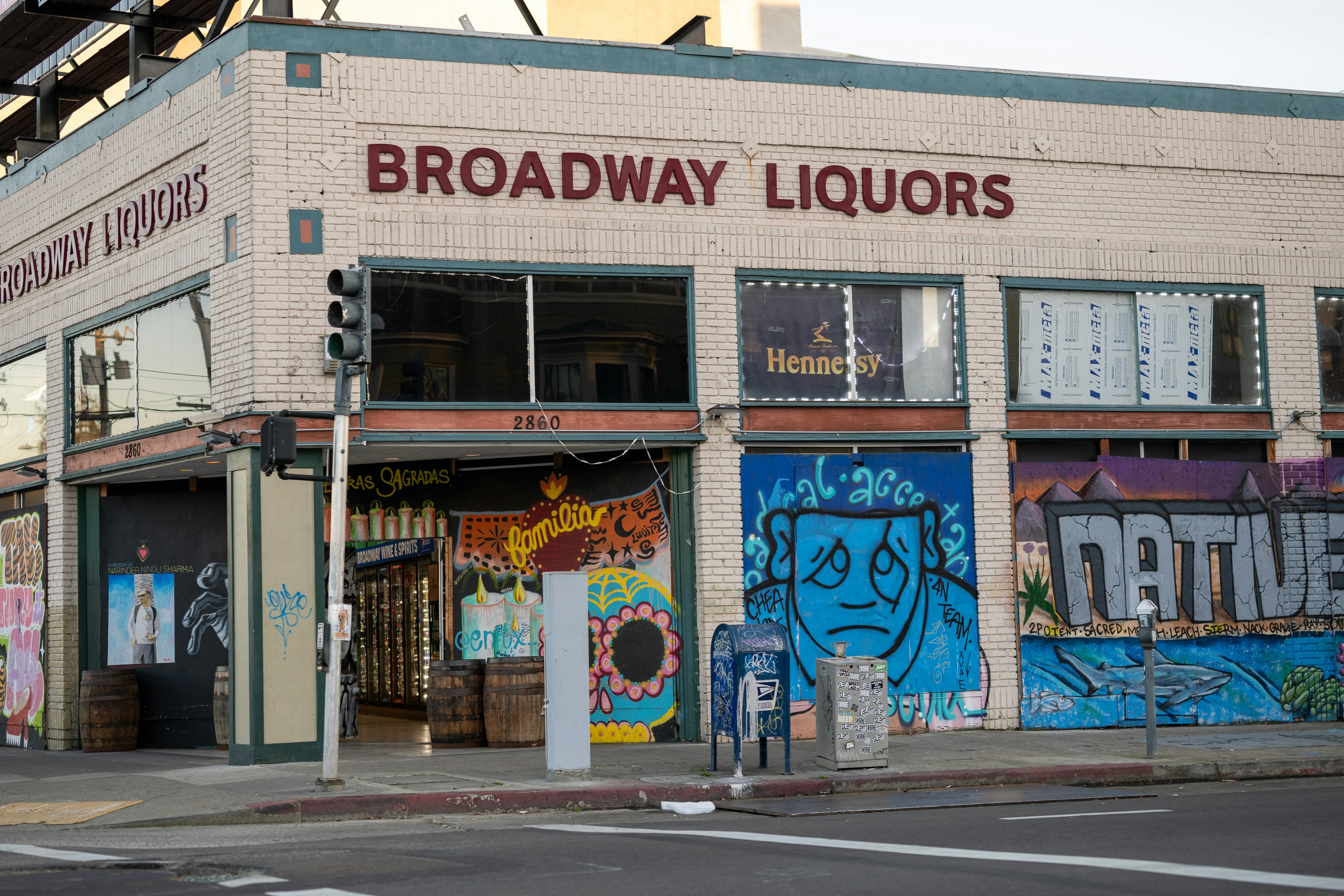 Colorful murals adorn the facade of Broadway Liquors in Oakland, California.