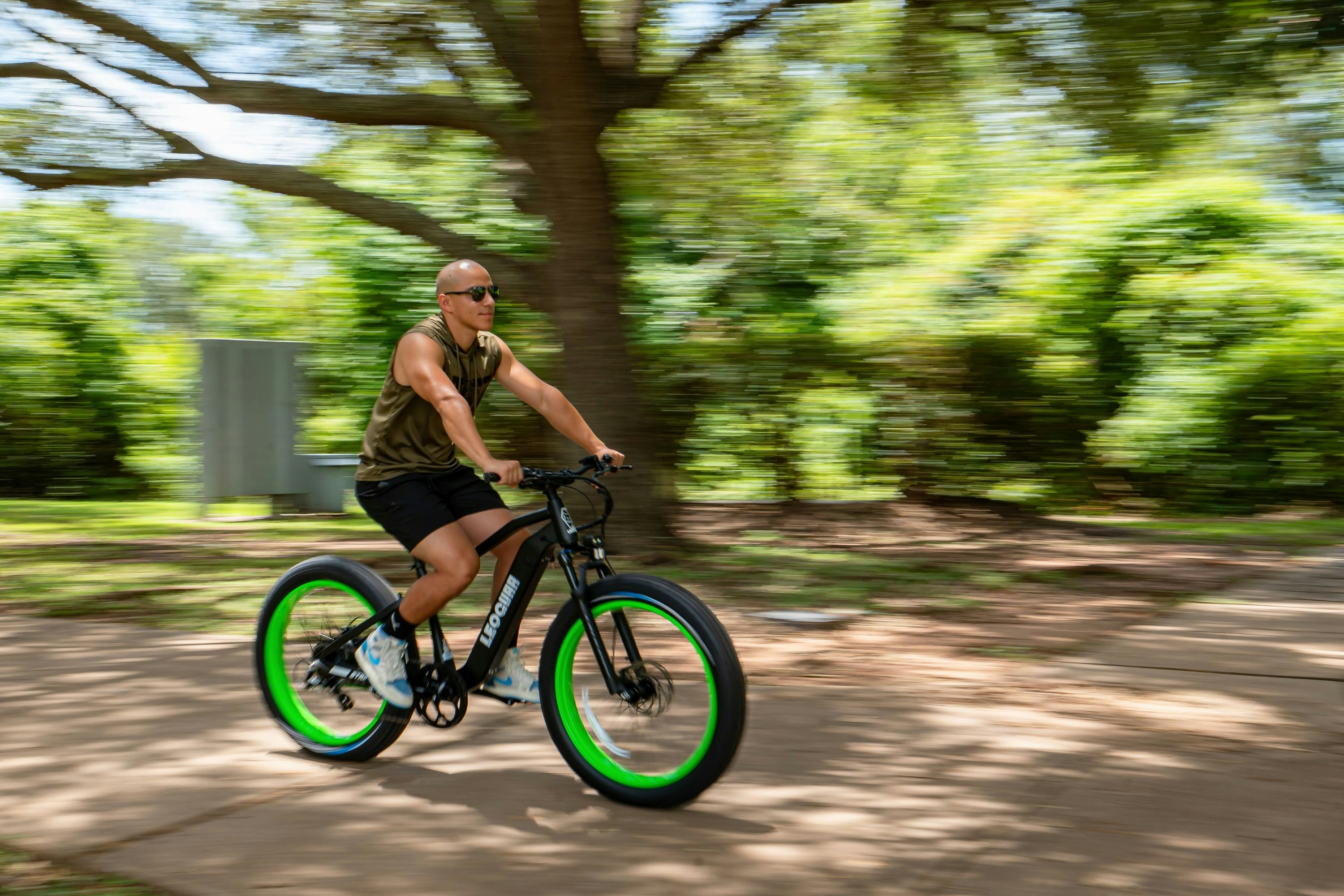 A man riding a bike down a street photo – Free Leoguar bike Image on ...