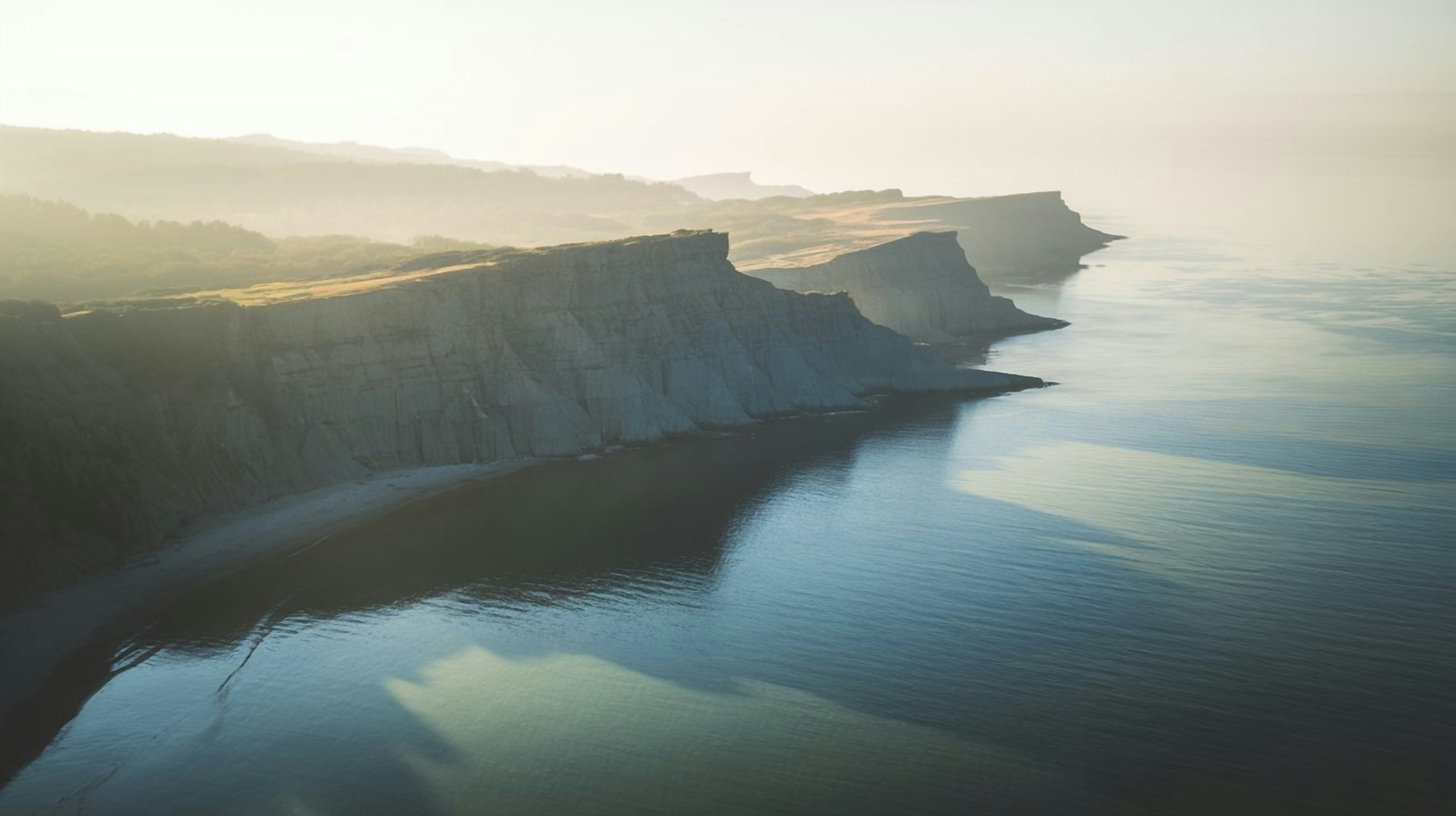 A large body of water with cliffs in the background photo – Free Nature ...