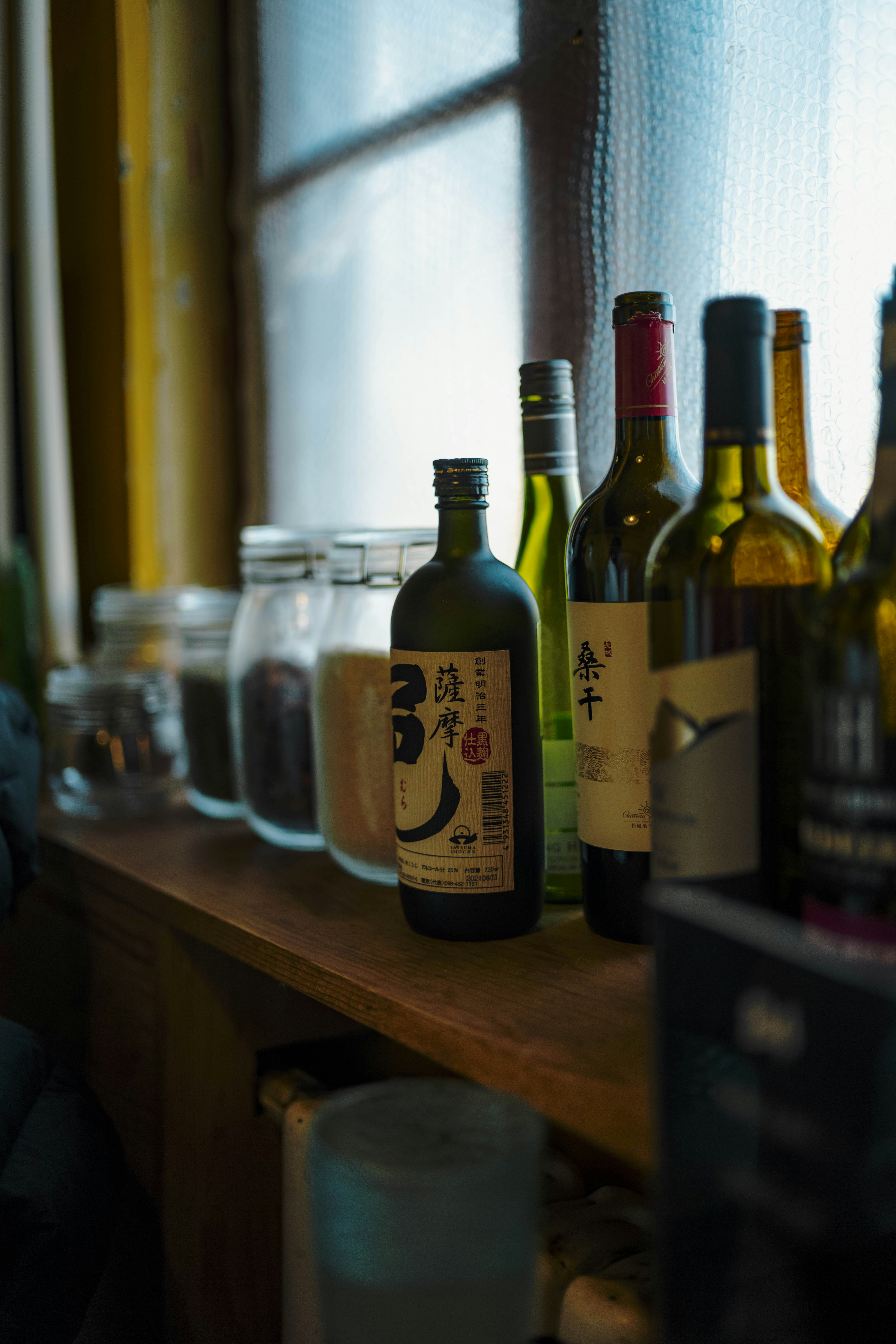 A wooden table topped with lots of bottles of wine