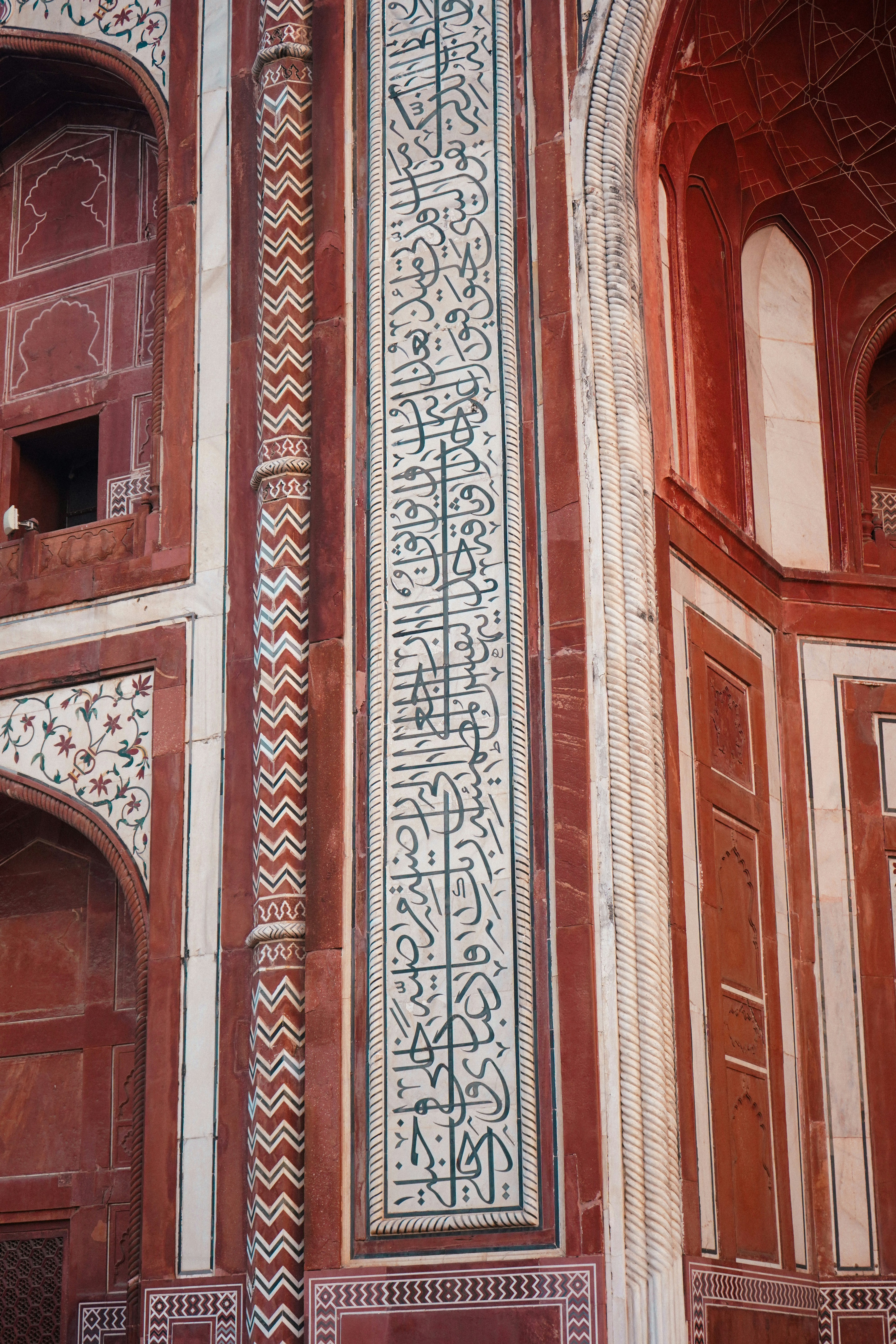 Vertical Scripted Facade: A Slice of Tajin-Red Carved Geometry
