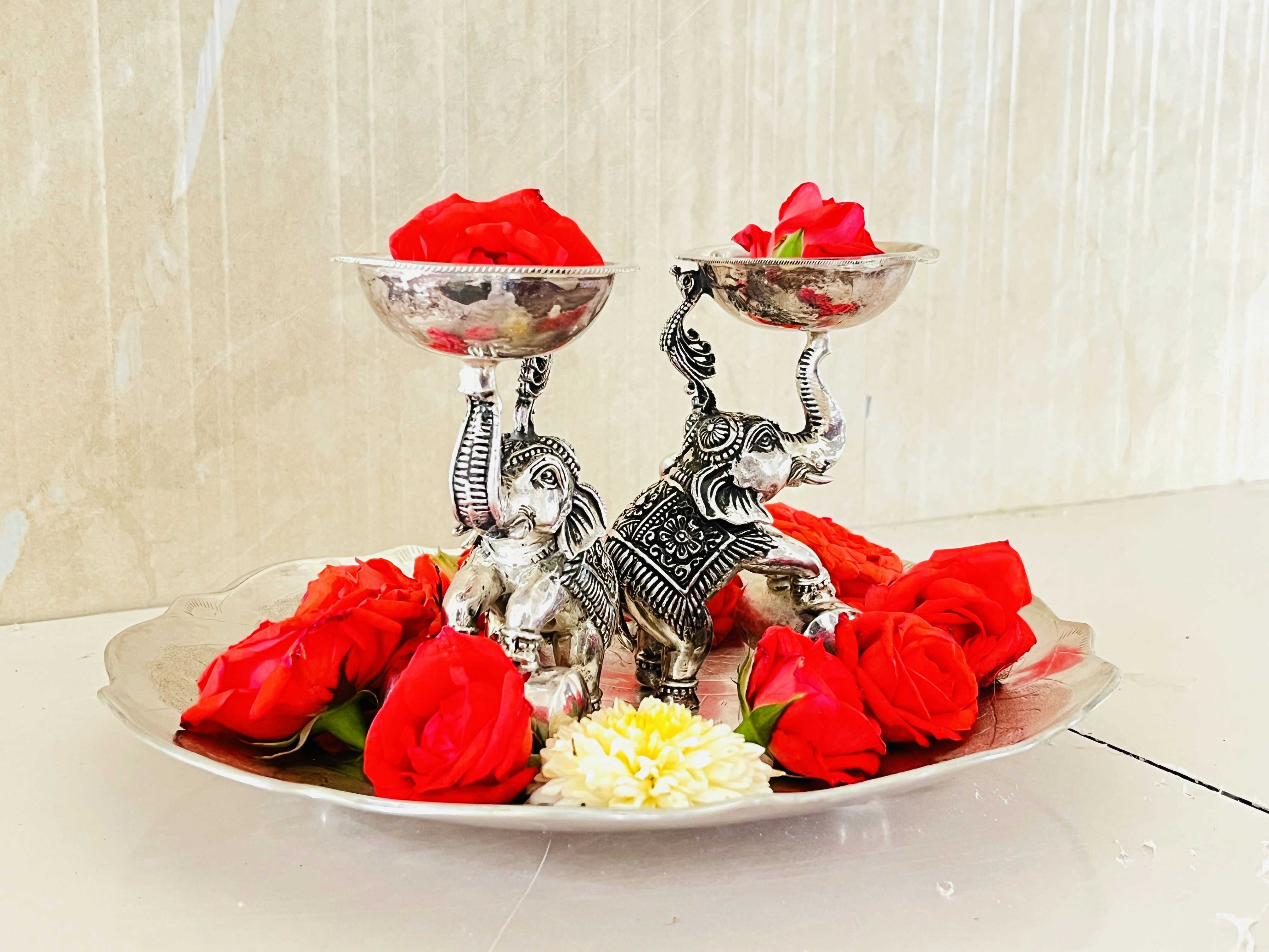 Ceremonial Elephant Holders Crown a Plate of Petals