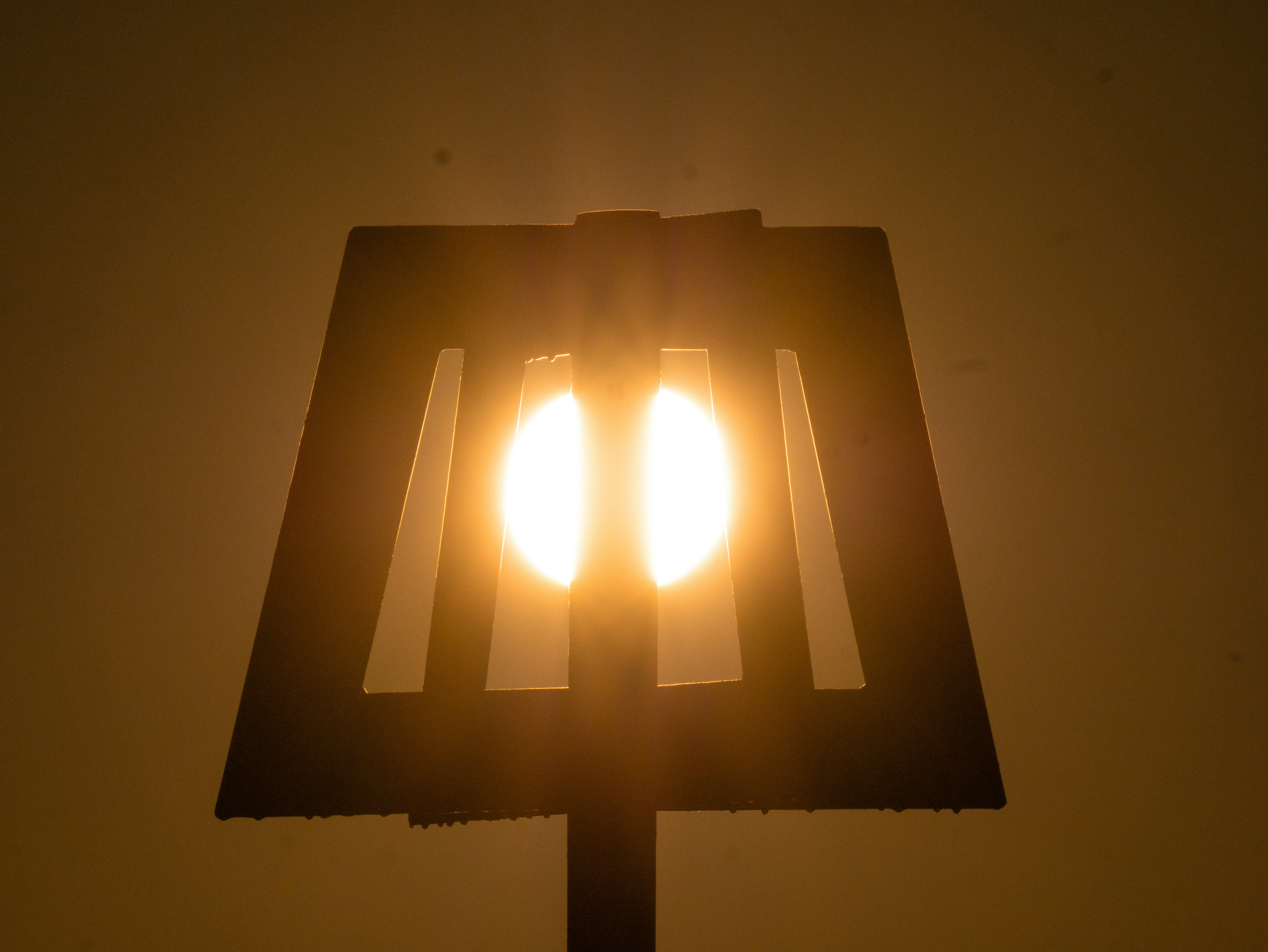 Ember Glow Through Geometric Lantern Slats