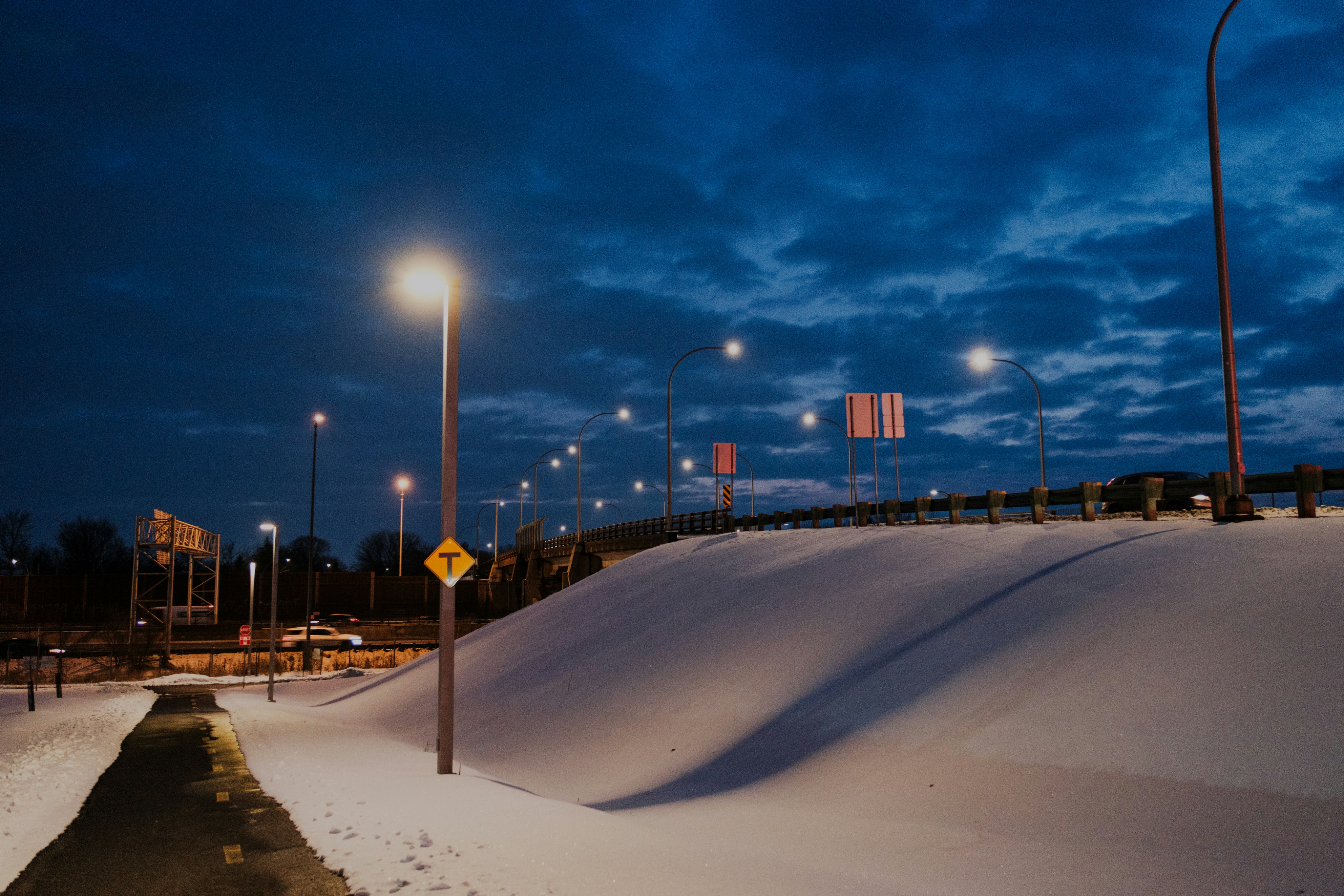 A snow covered road at night with street lights photo – Free Longueuil ...