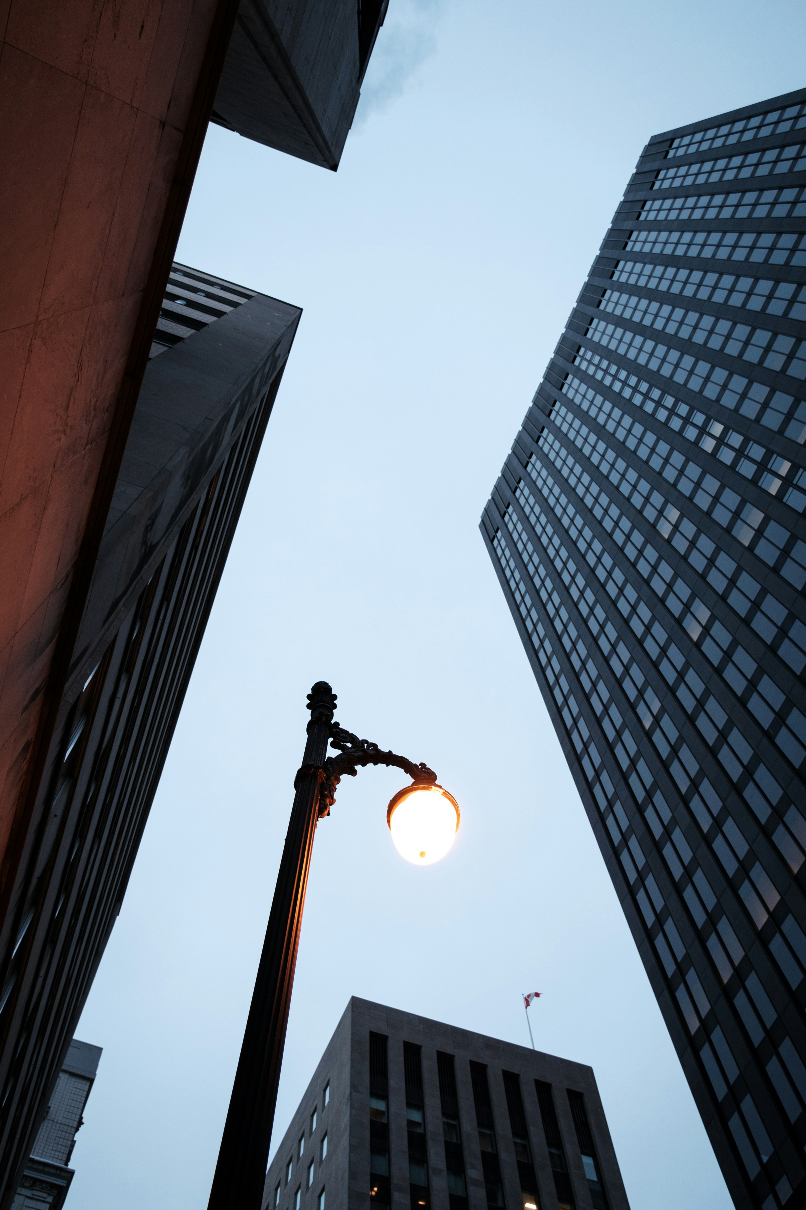 A street light in between two tall buildings photo – Free Montreal ...