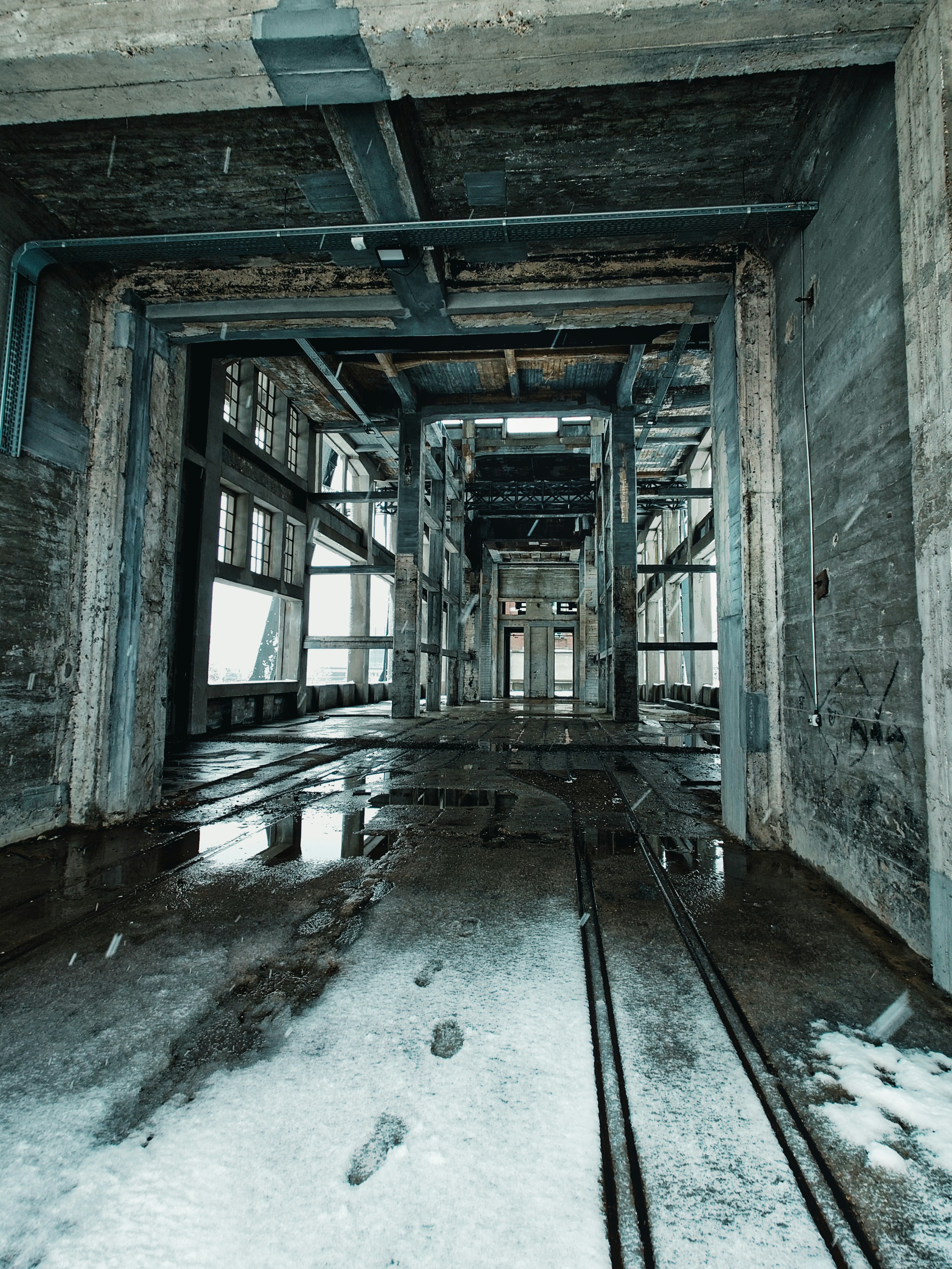 Vanishing Rails: A Snow-Washed Corridor in an Abandoned Factory