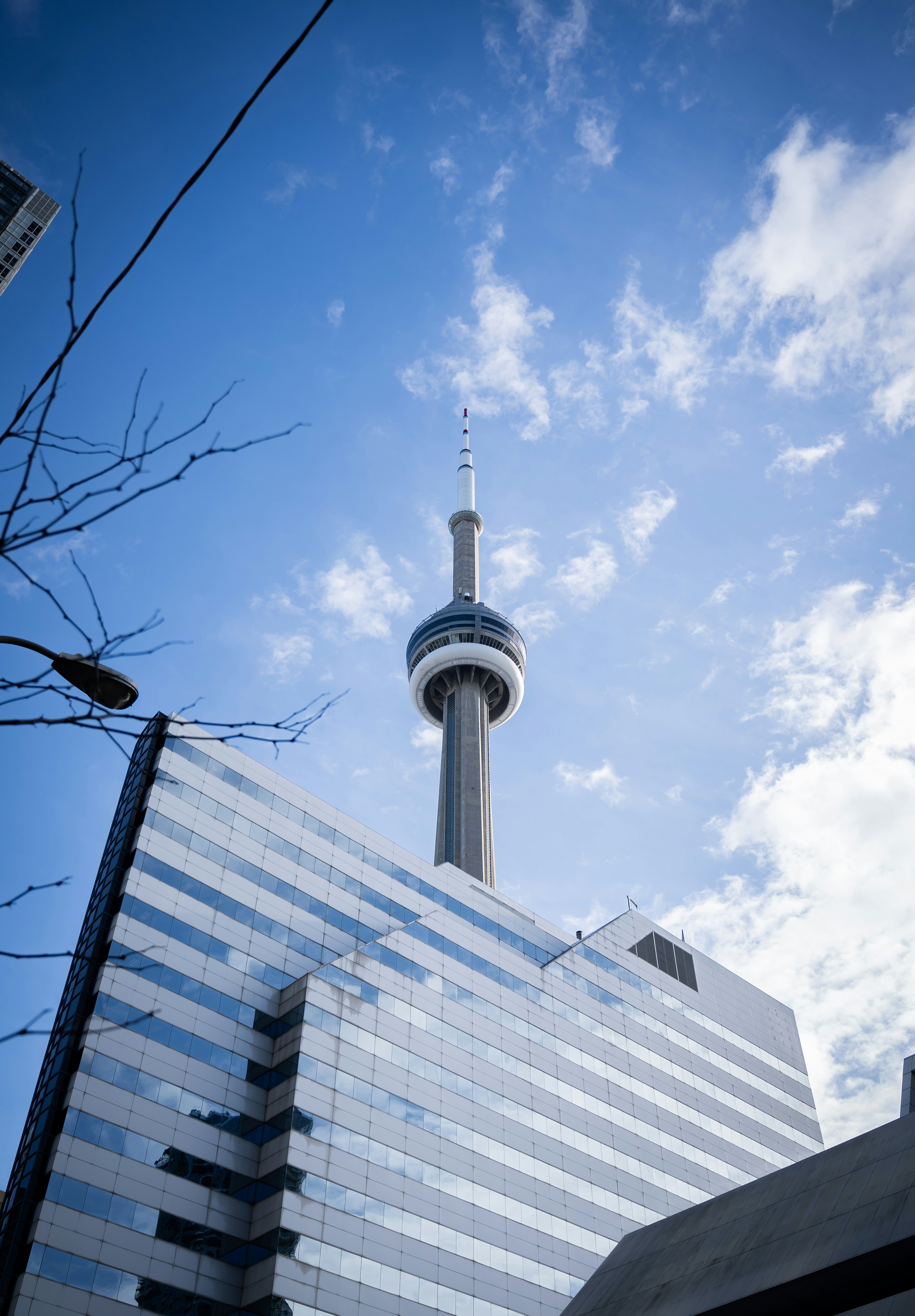 A tall building with a sky scraper in the background photo – Free ...