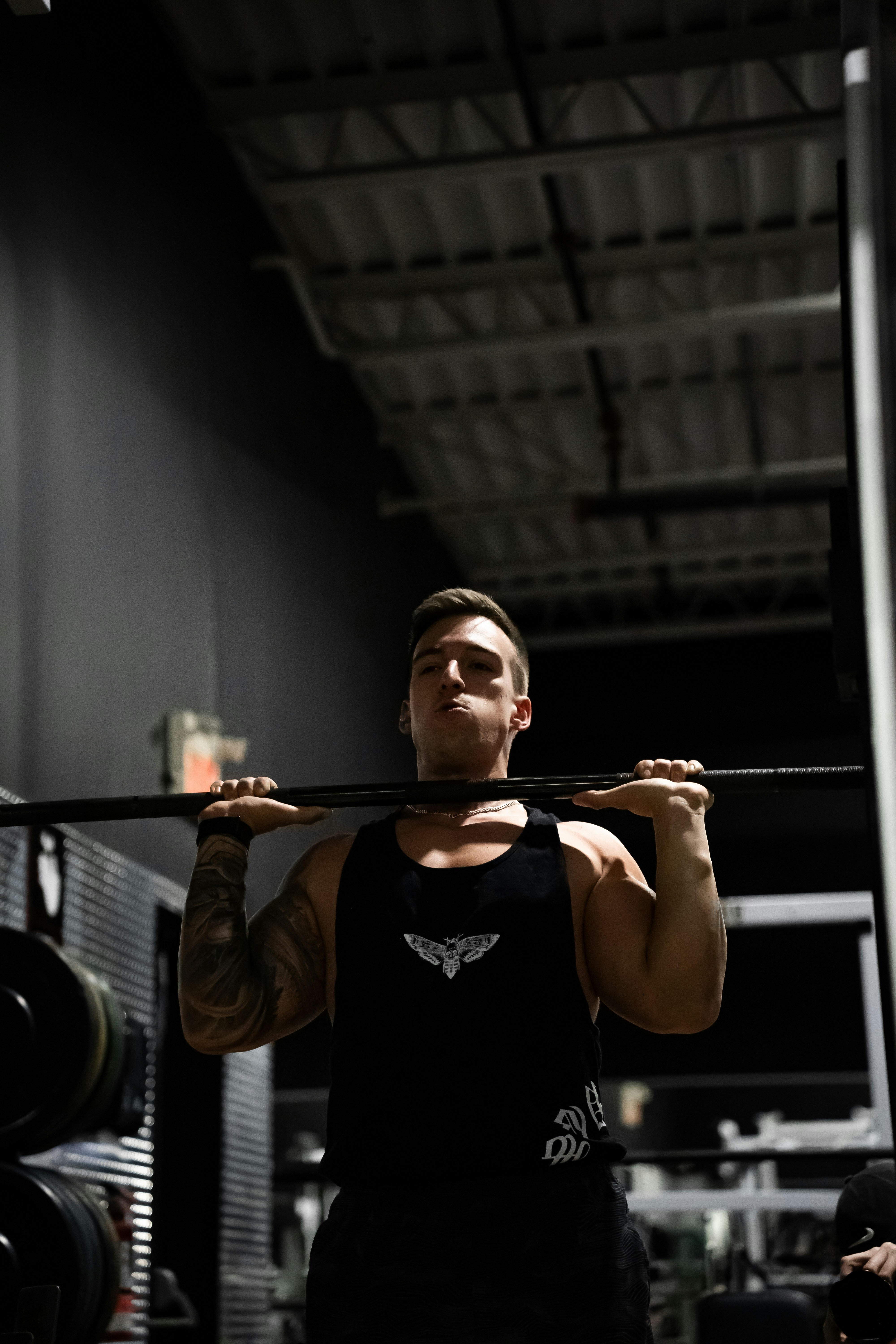 A man holding a barbell in a gym photo – Free Gym Image on Unsplash