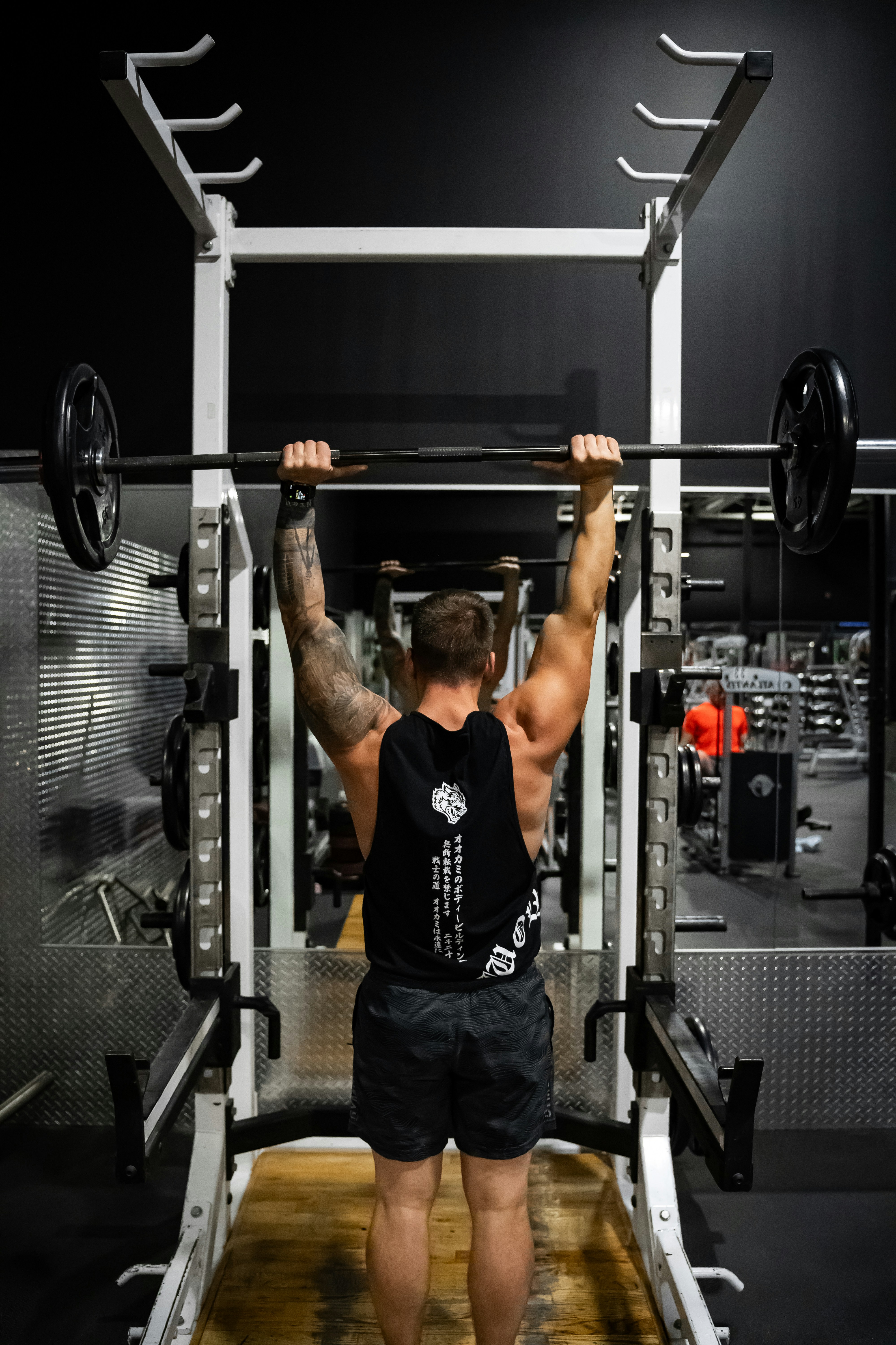 A man in a gym lifting a barbell photo – Free Exercise Image on Unsplash